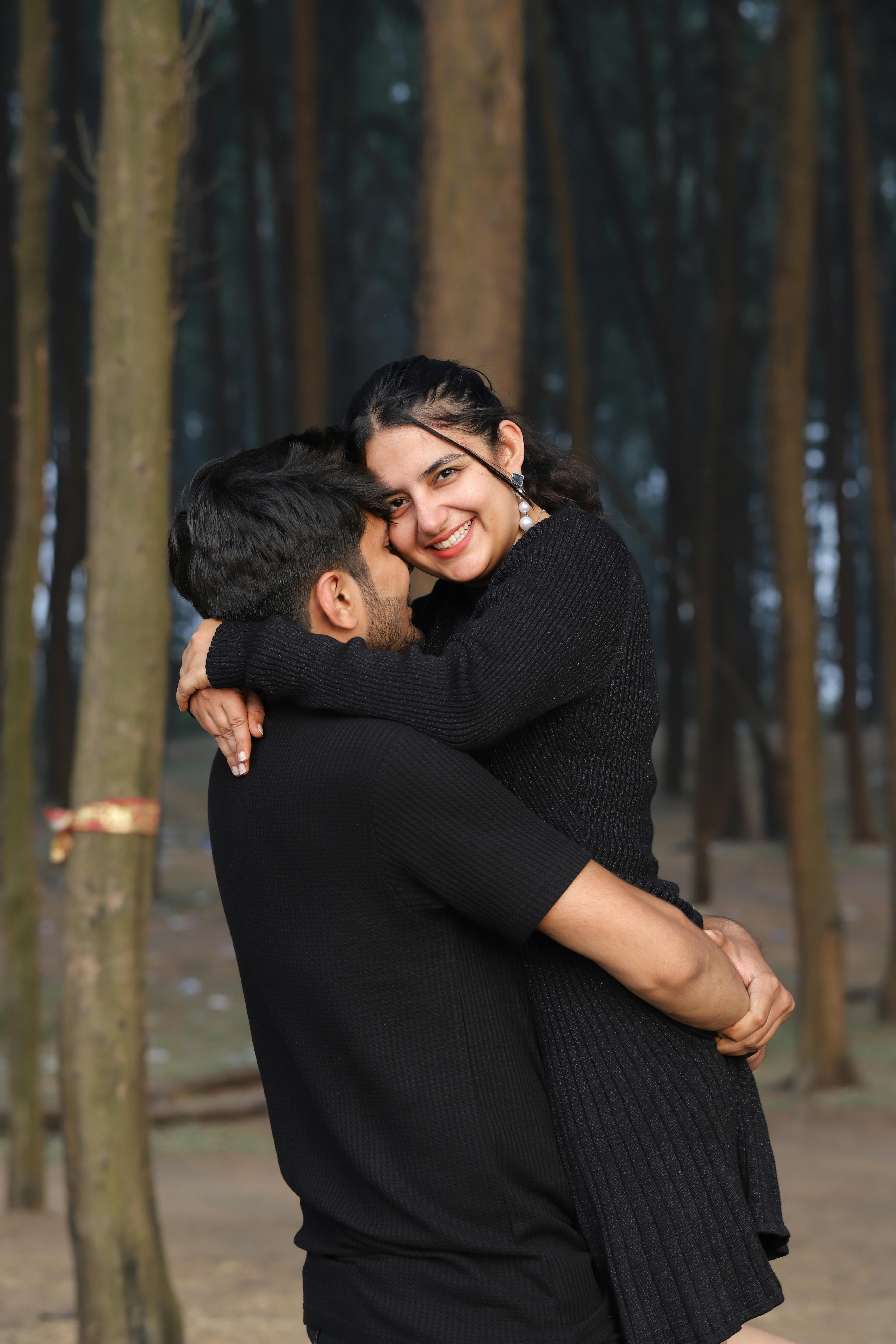 Romantic Couple Embracing in Forest Setting · Free Stock Photo