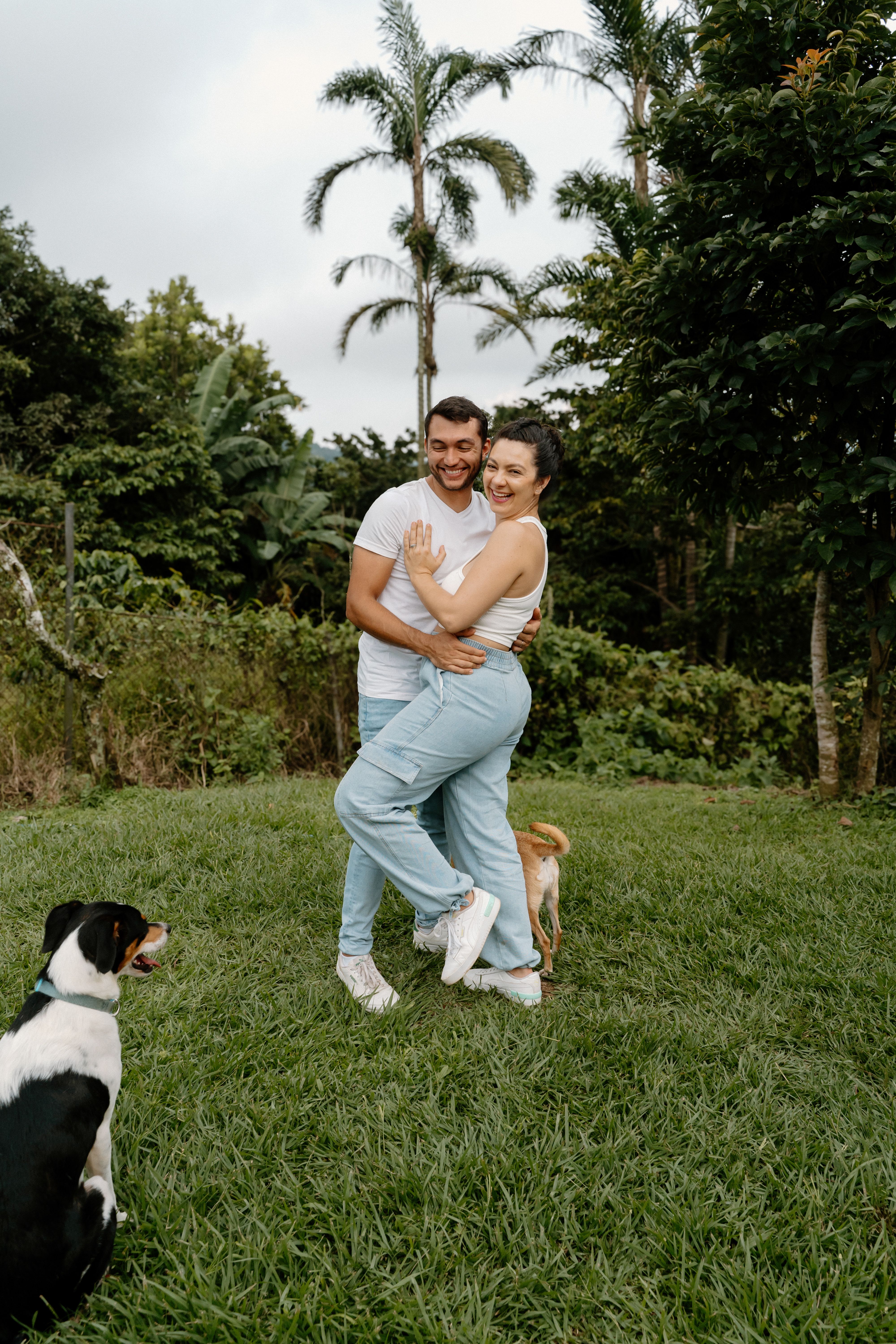 Happy Couple Embracing Outdoors with Dogs in Costa Rica · Free Stock Photo