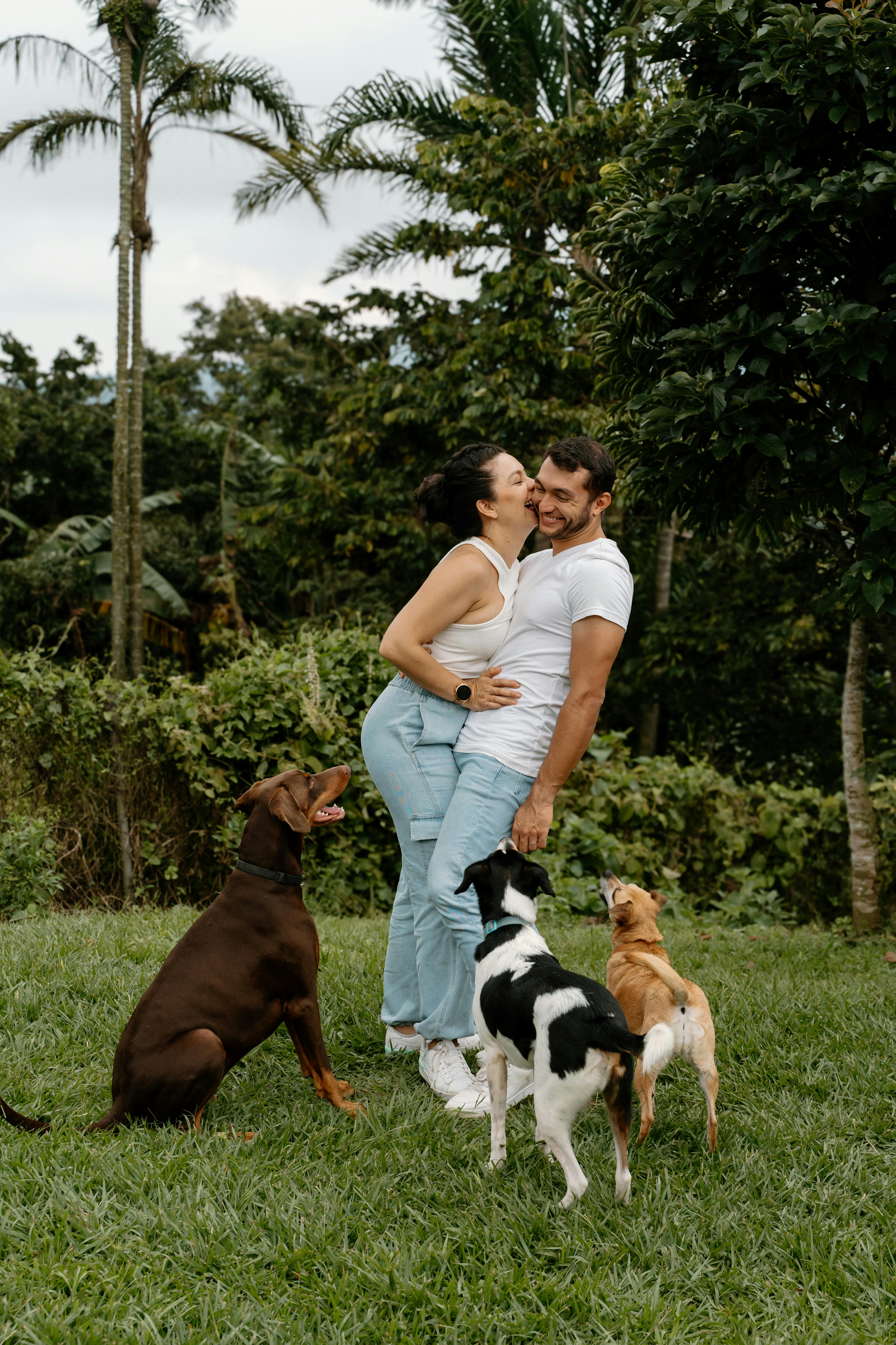 Couple Embracing with Dogs in Lush Costa Rica · Free Stock Photo