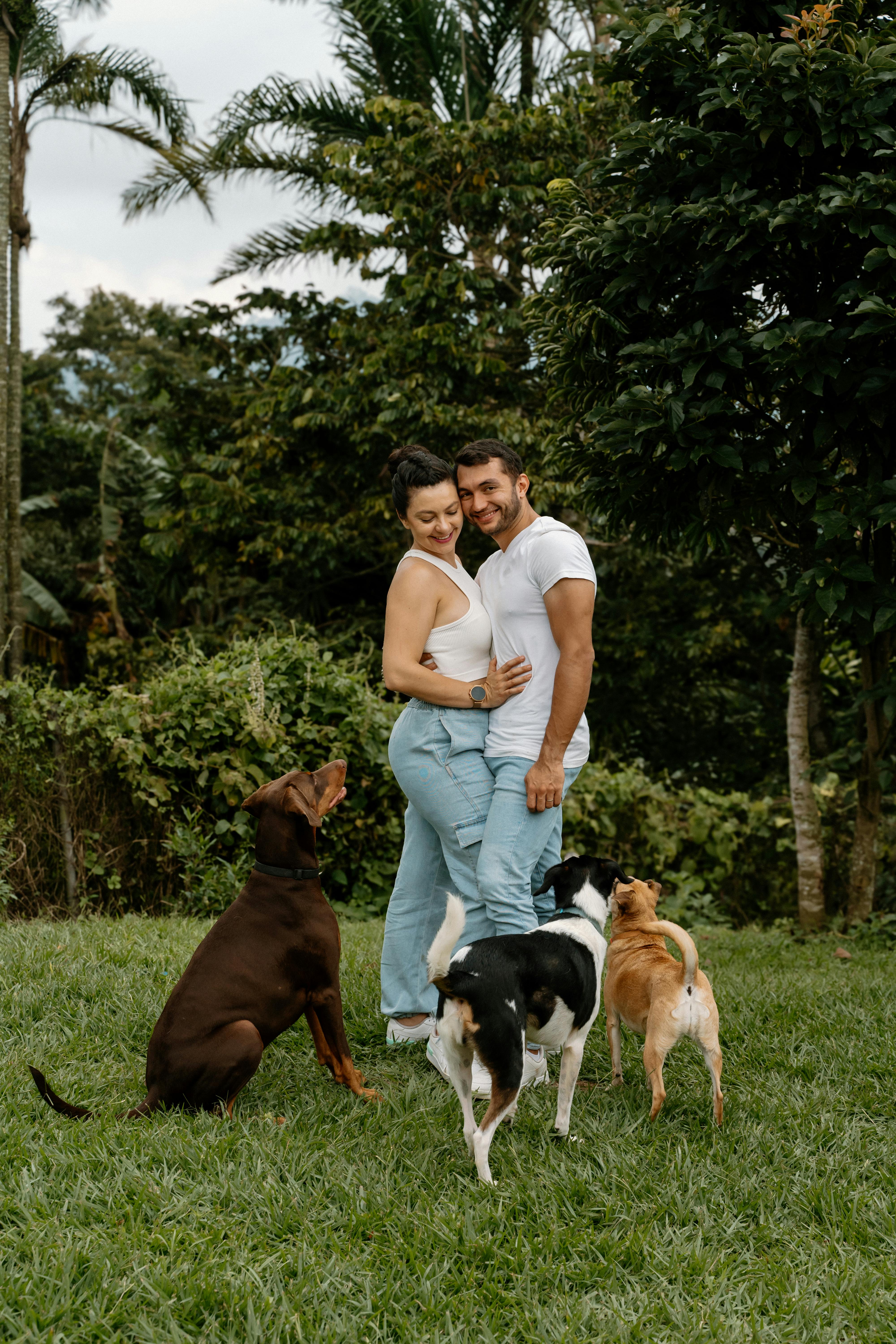 Couple Embracing with Dogs Outdoors in Costa Rica · Free Stock Photo