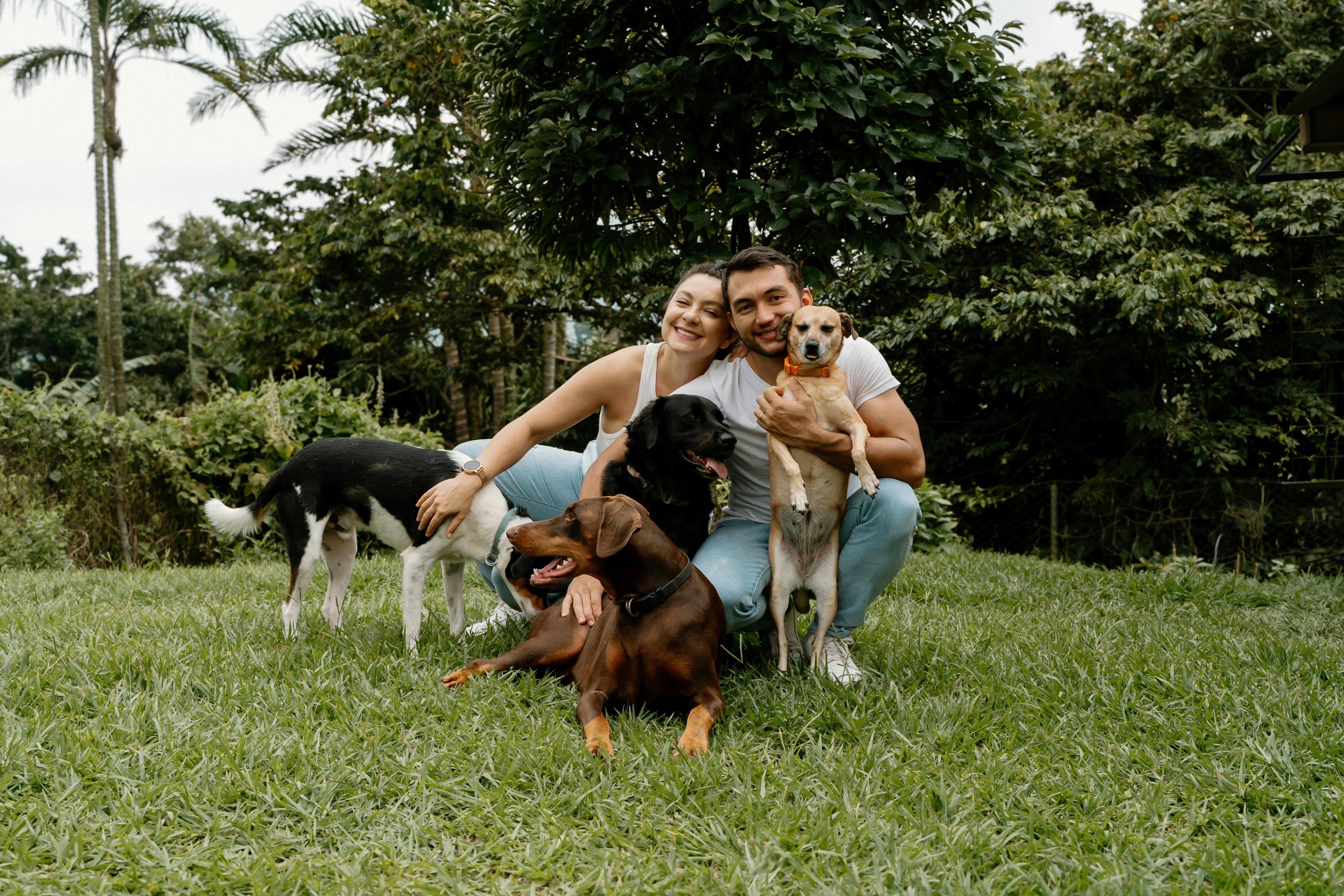 Happy Couple with Dogs in Costa Rican Garden · Free Stock Photo