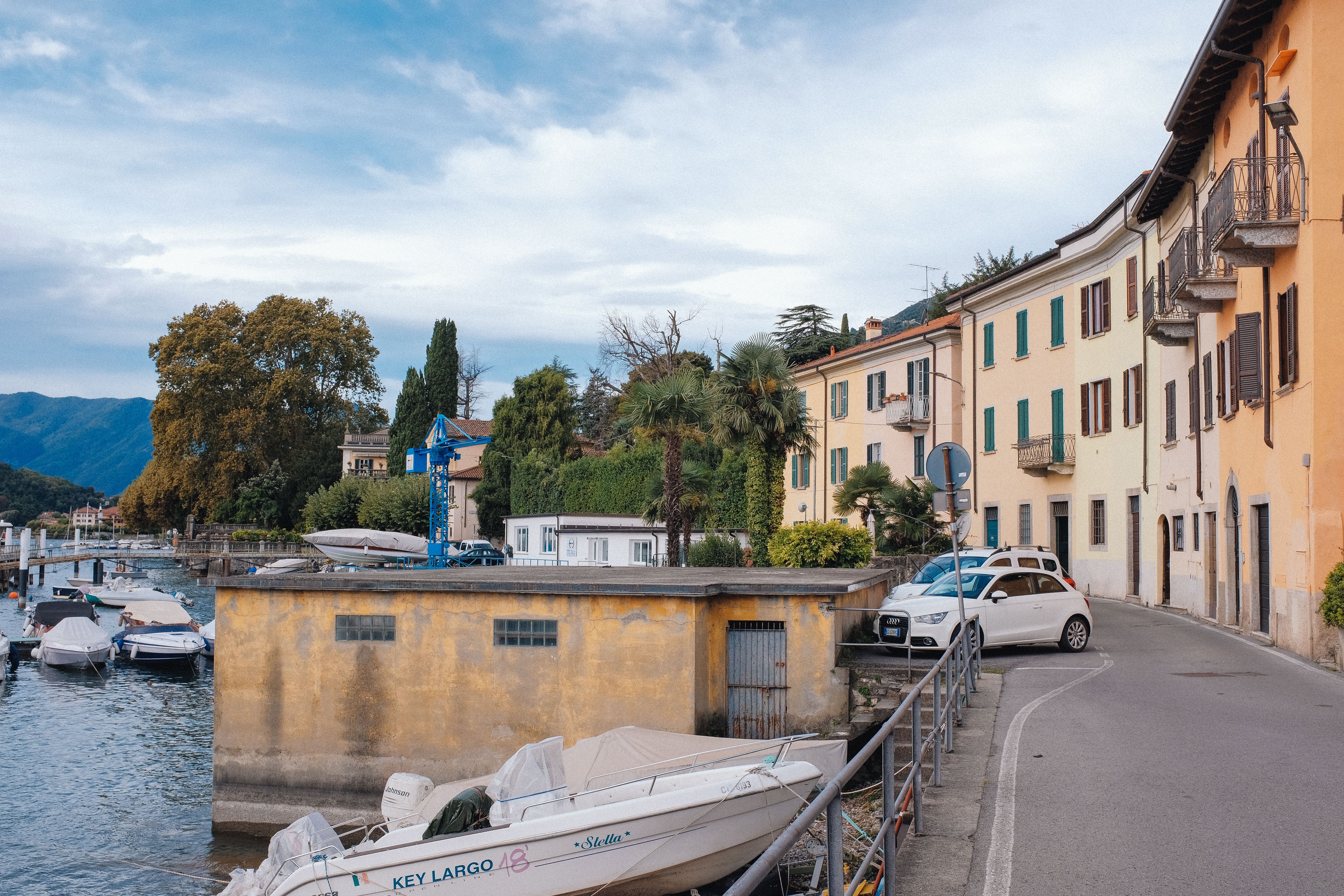 Scenic Waterfront Town with Boats and Yellow Buildings · Free Stock Photo
