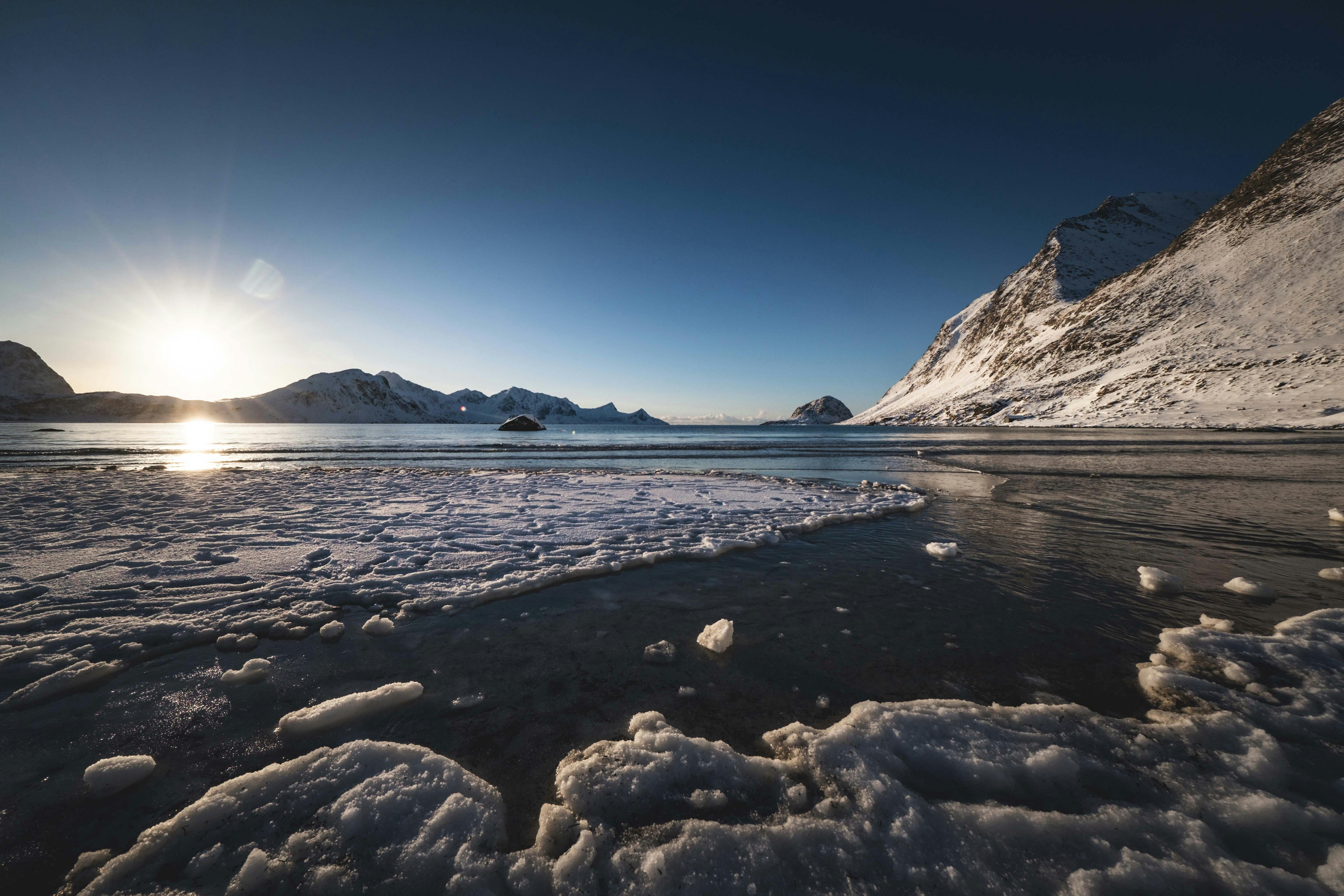 Serene Arctic Seascape with Ice and Sun · Free Stock Photo