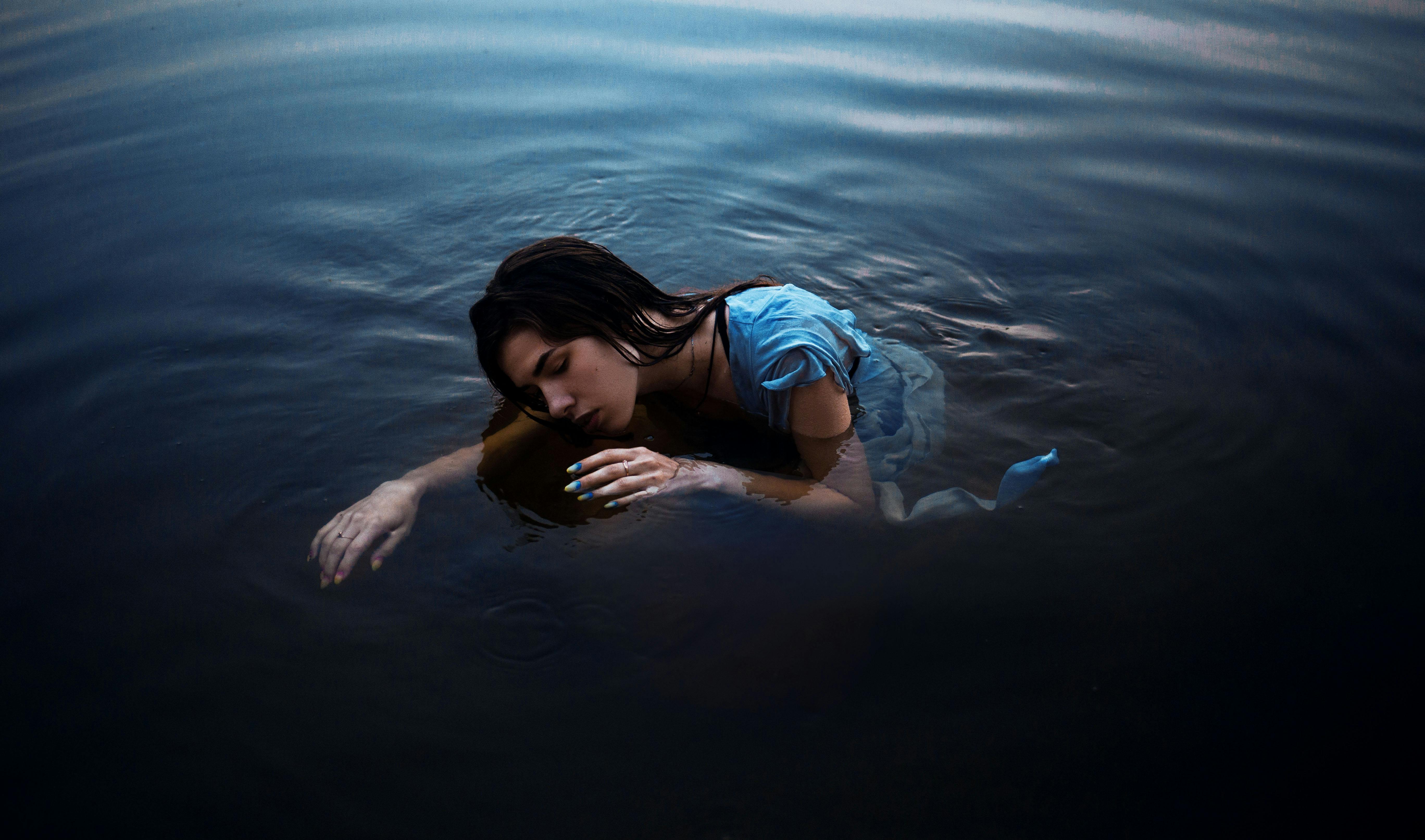Serene Woman in River Wearing Blue Dress · Free Stock Photo