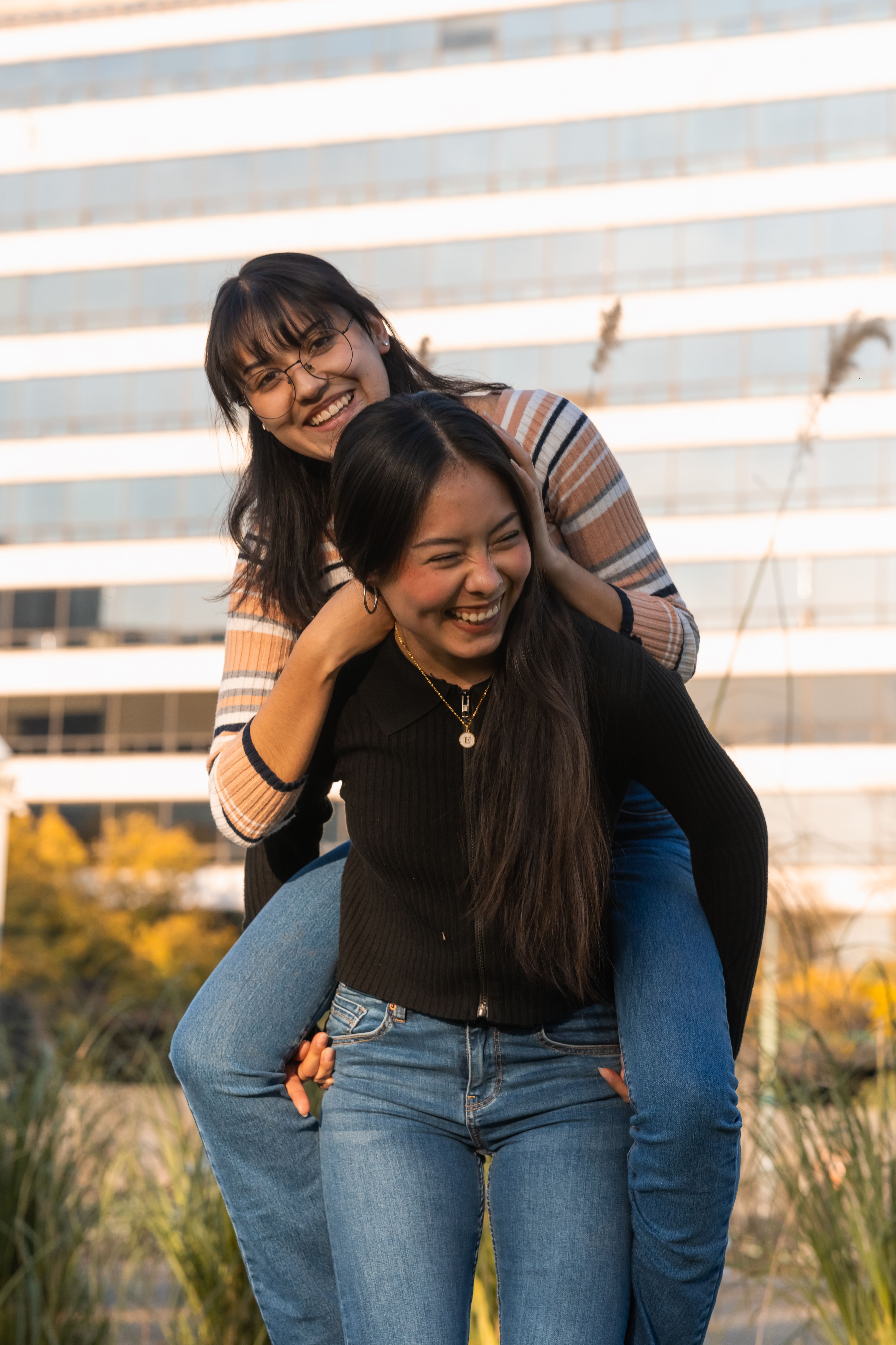 Two Friends Enjoying Piggyback Ride Outdoors · Free Stock Photo