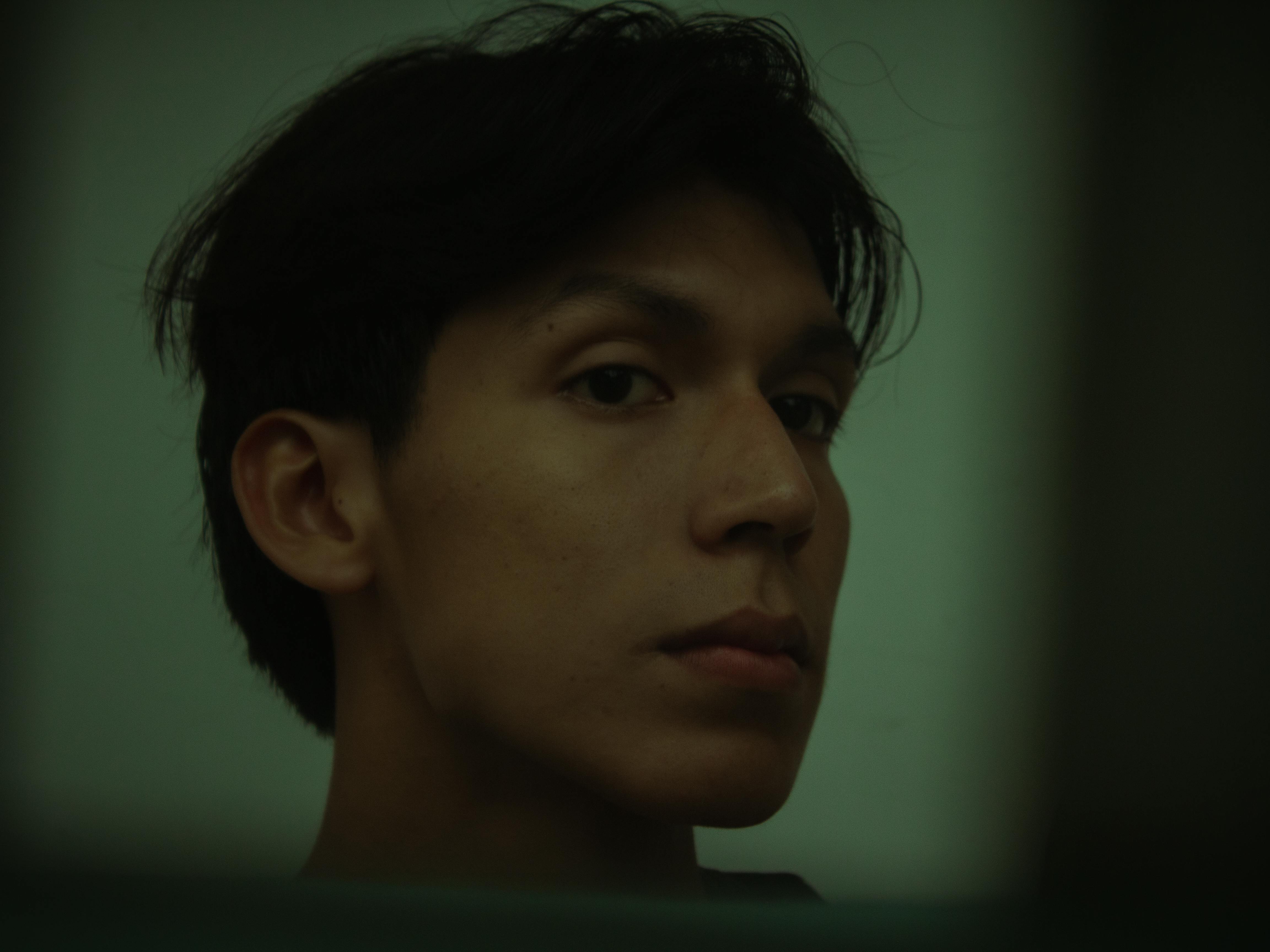 Portrait of Young Man with Introspective Expression · Free Stock Photo