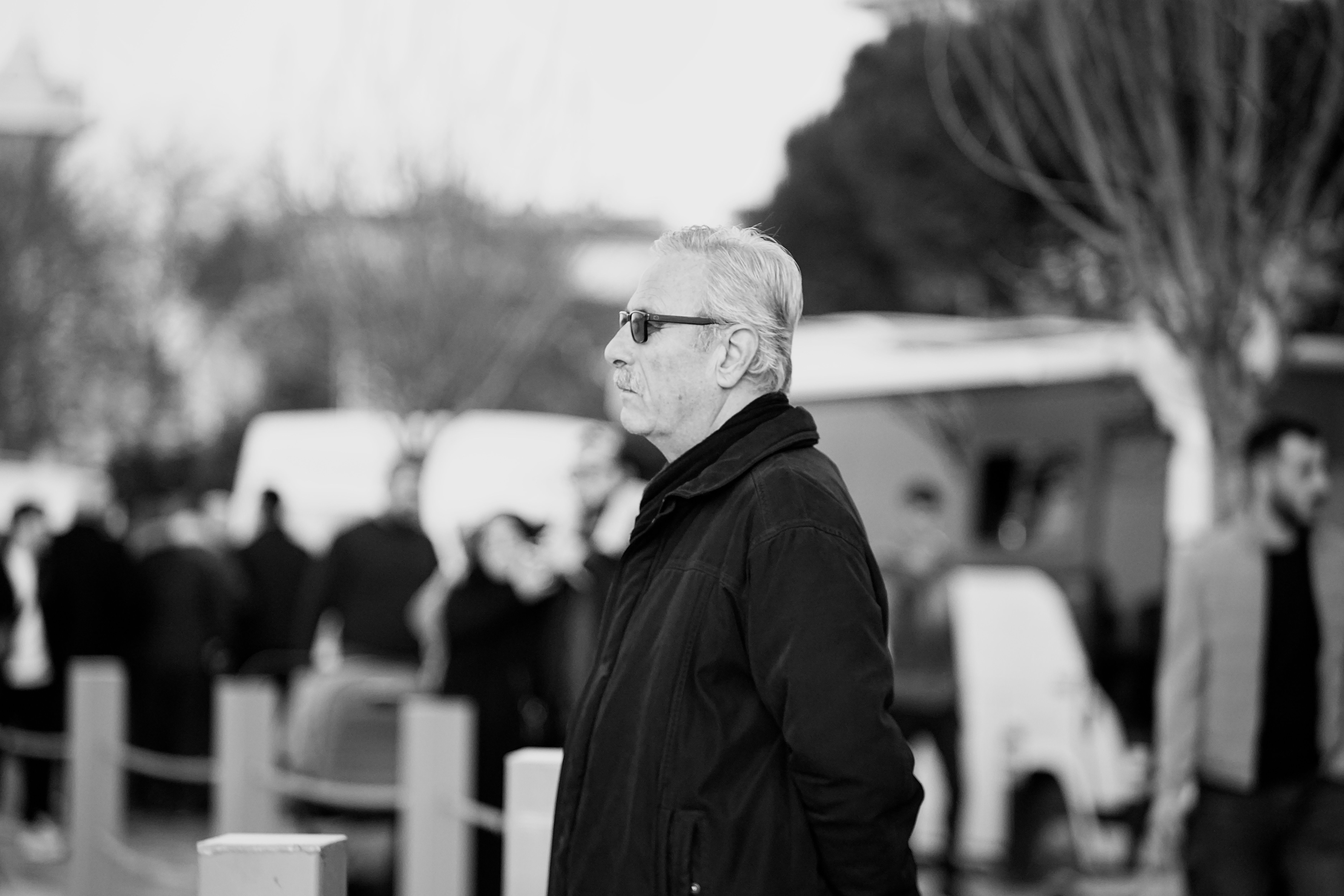 Elderly Man Observing Outdoor Scene in Black and White · Free Stock Photo