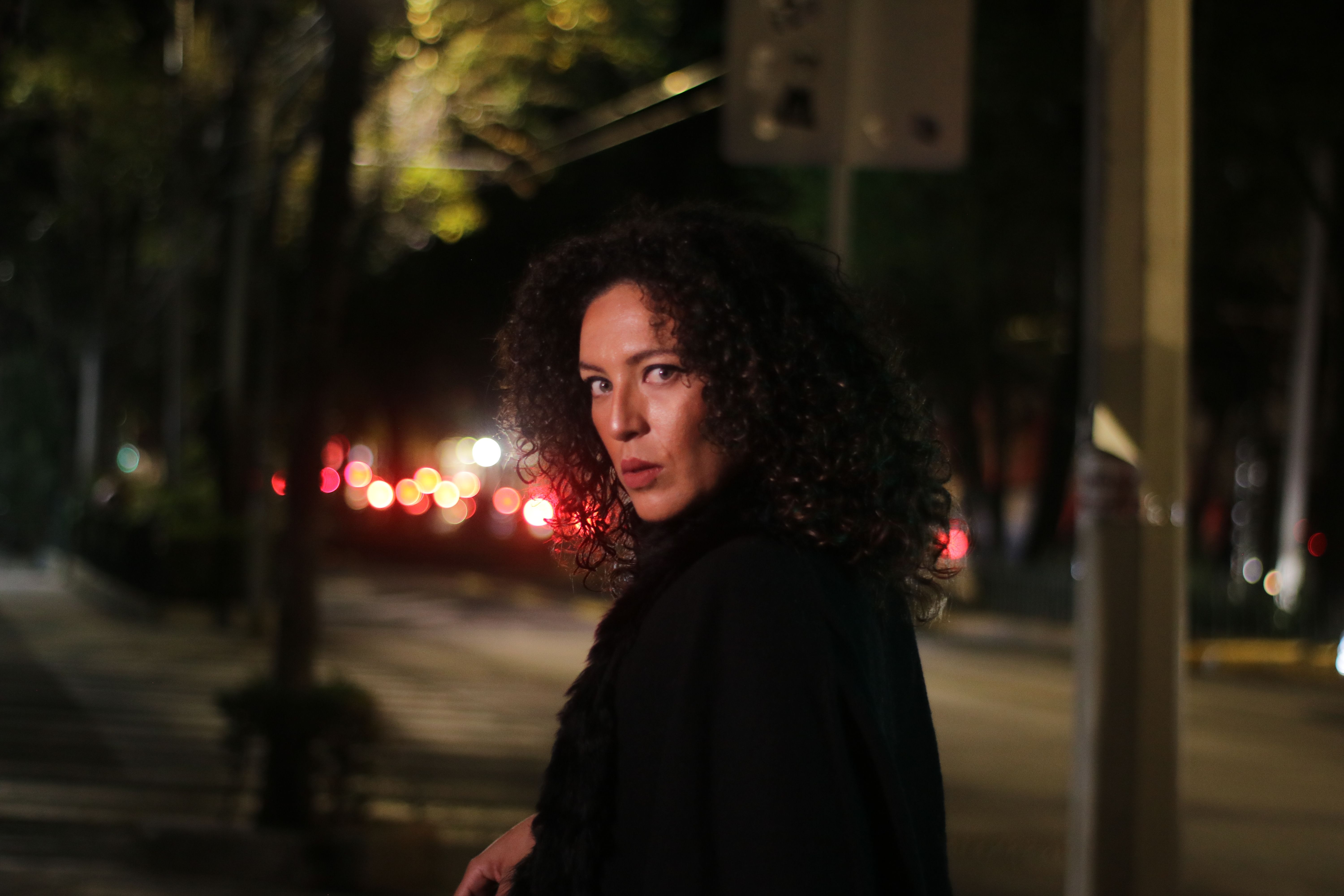 Woman with Curly Hair on Street at Night · Free Stock Photo