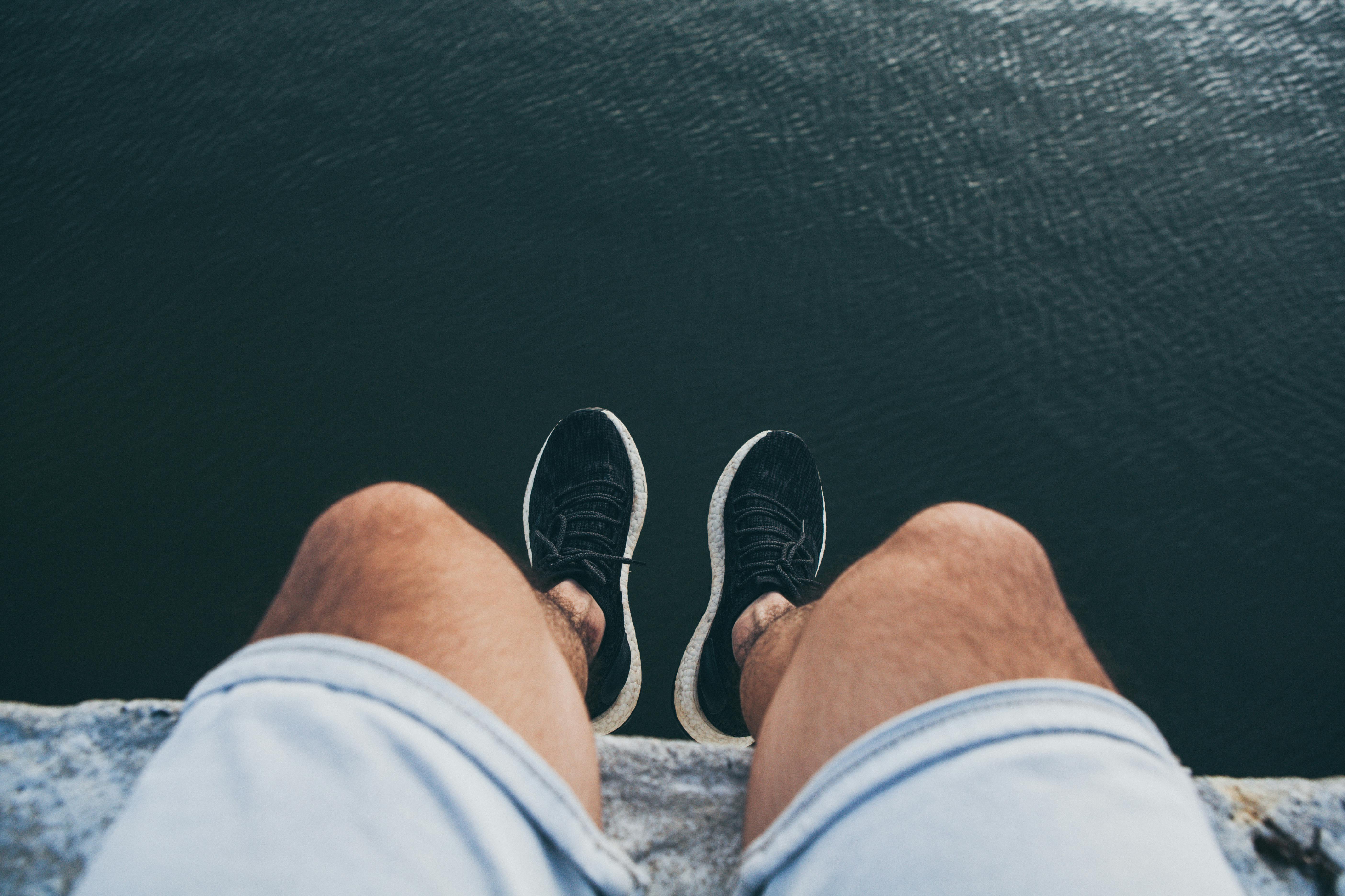 POV of a Person Sitting on a Ledge by the Seaside · Free Stock Photo