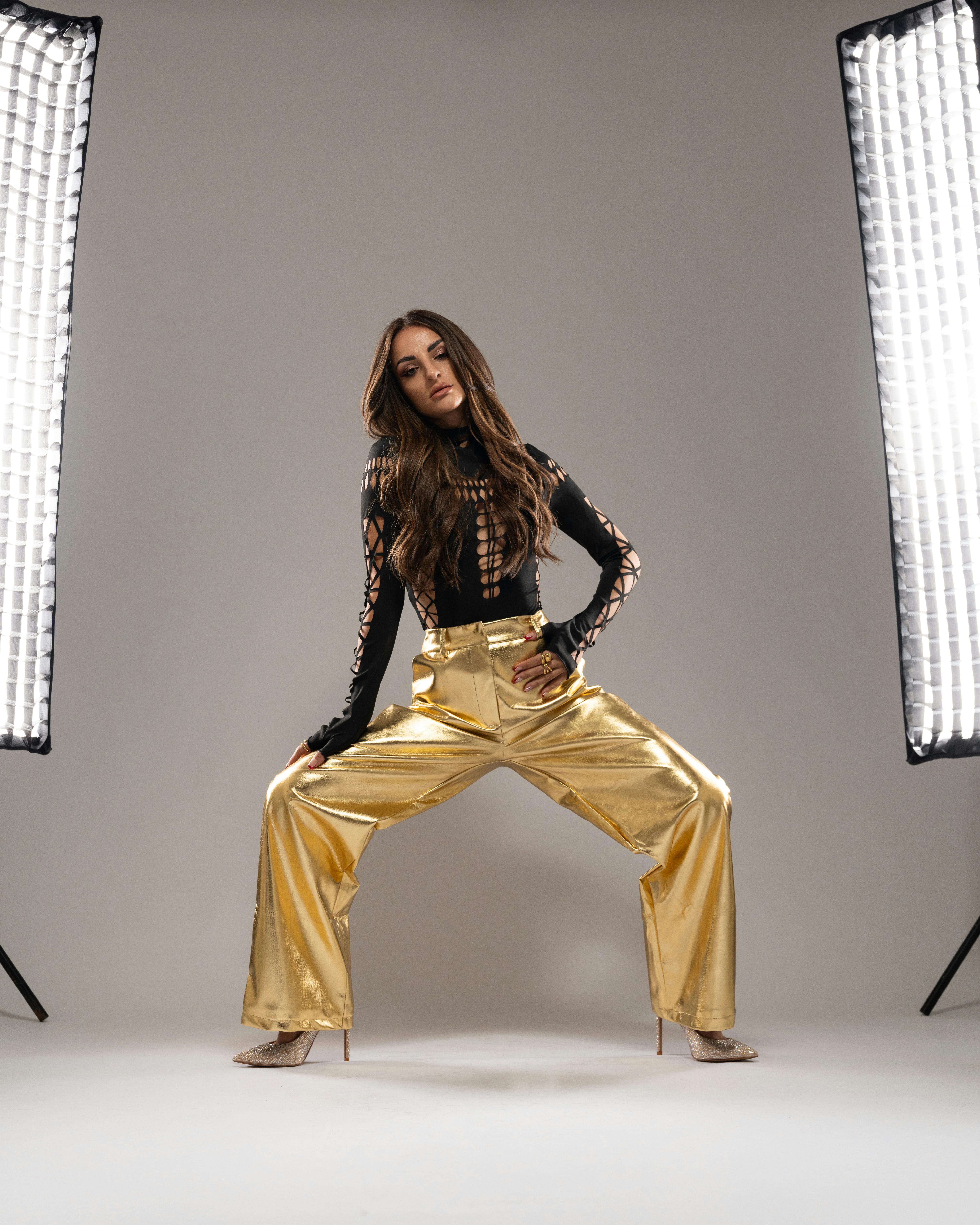 Fashionable Model in Golden Pants Striking a Pose · Free Stock Photo