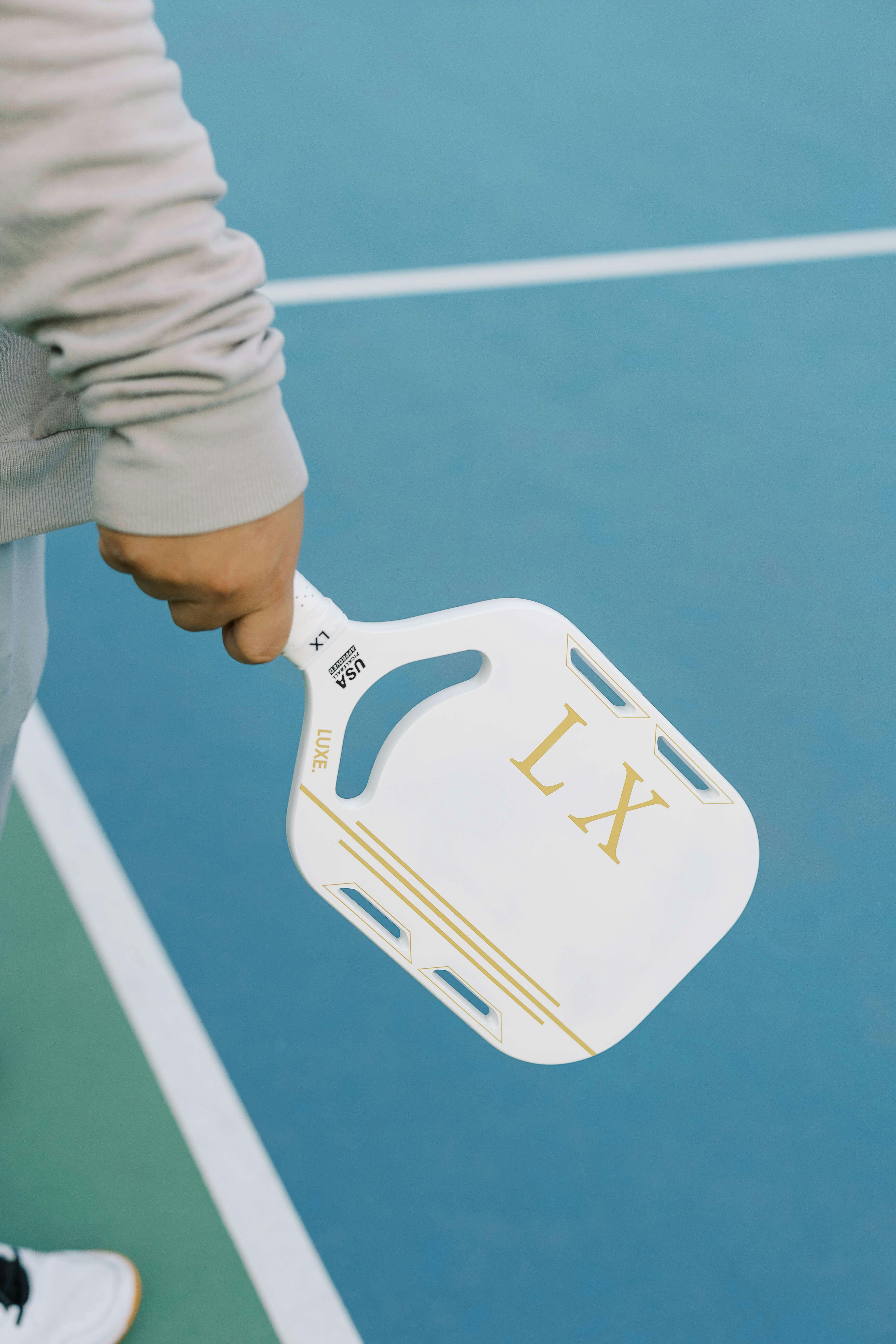 Hand Holding Pickleball Paddle on Court · Free Stock Photo