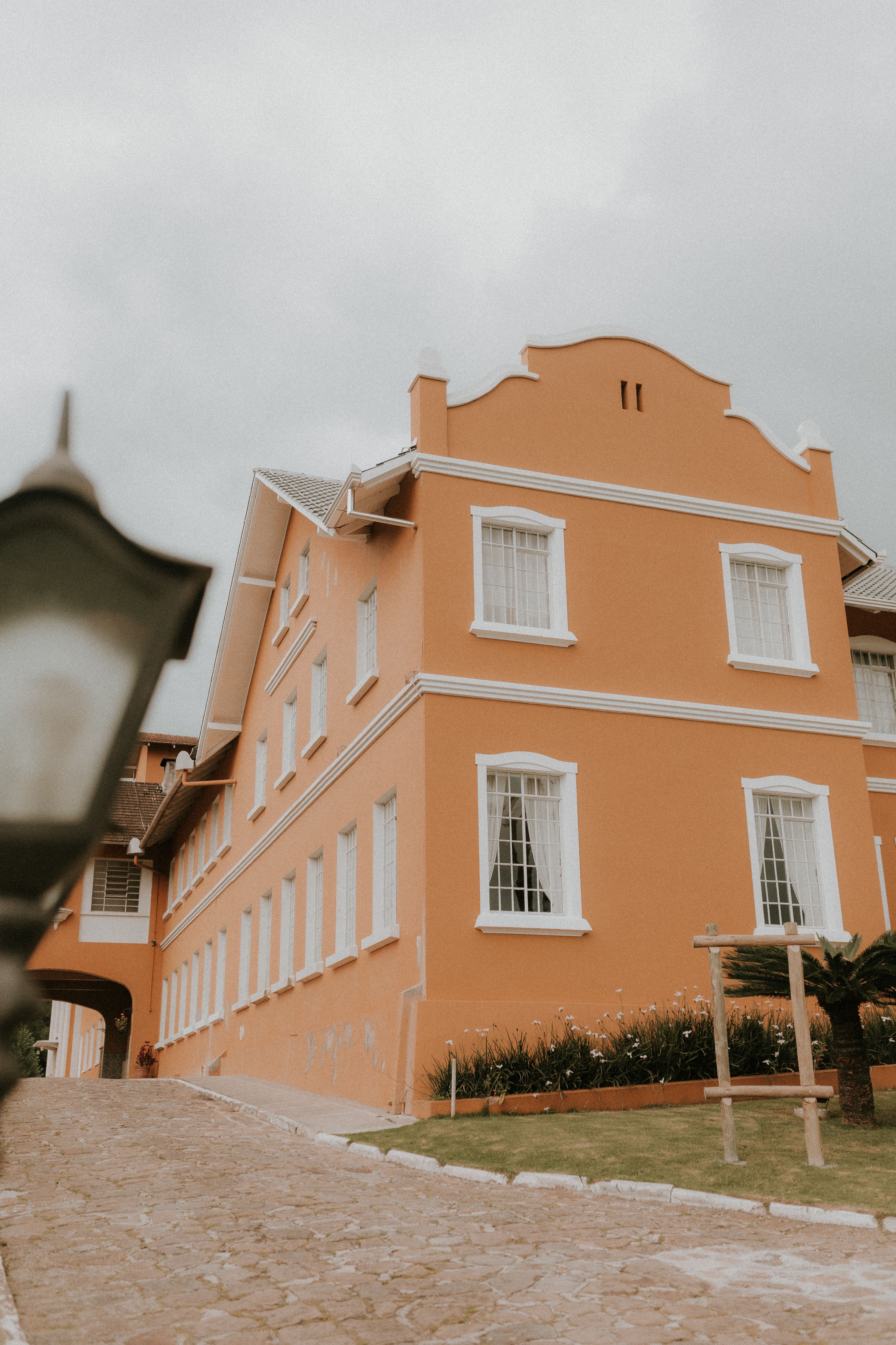 Elegant Orange Building on Cloudy Day · Free Stock Photo