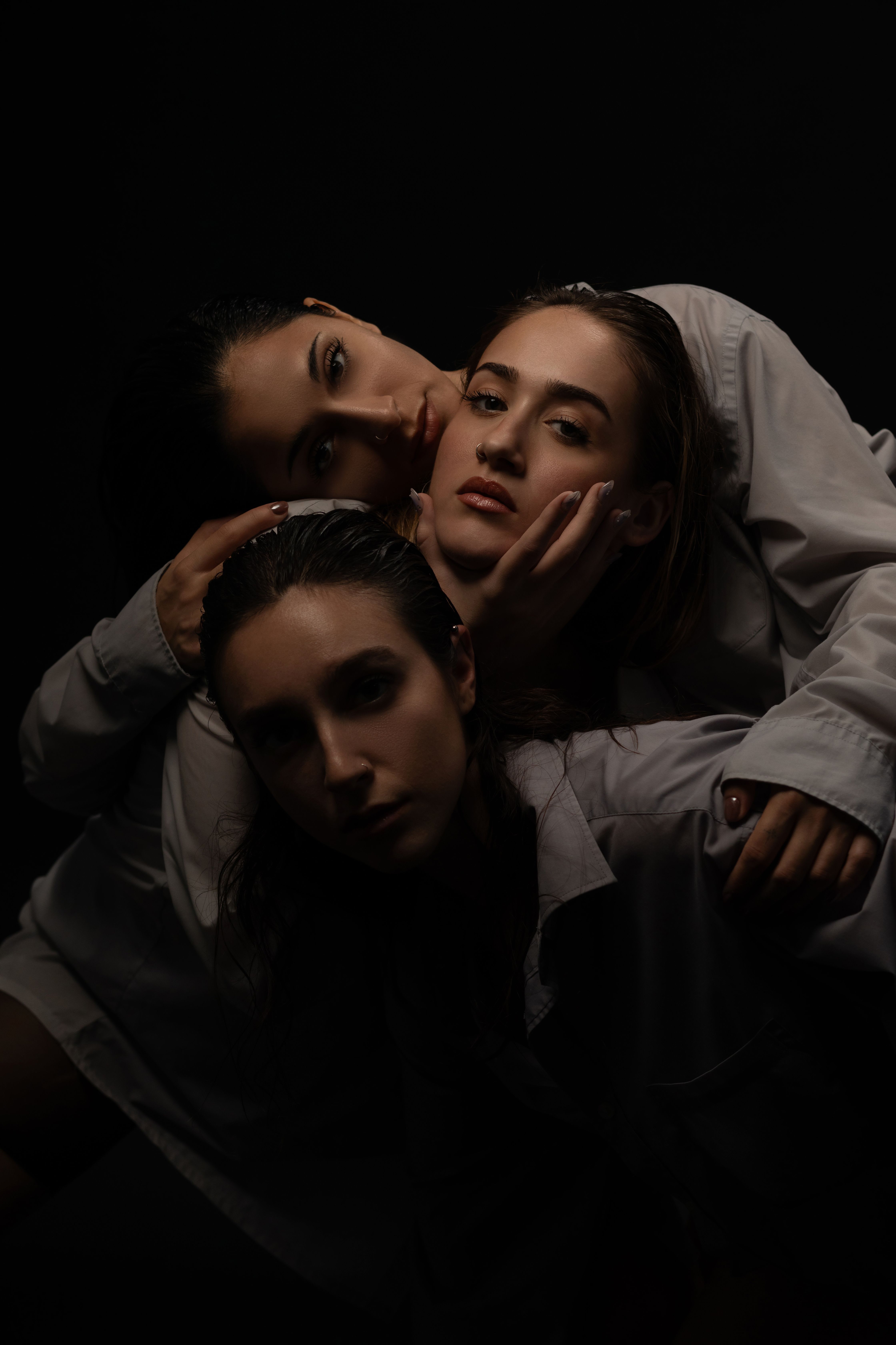 Artistic Portrait of Three Women in Dim Light · Free Stock Photo