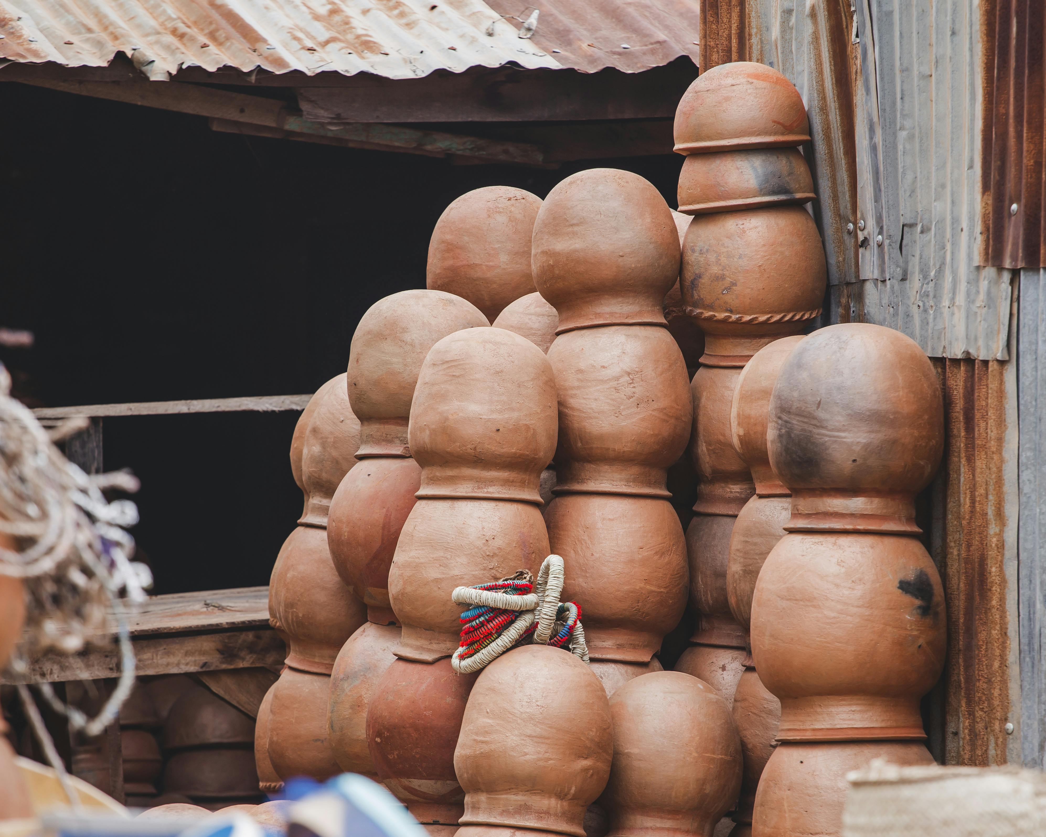 Traditional Clay Pots Stacked Outdoors · Free Stock Photo