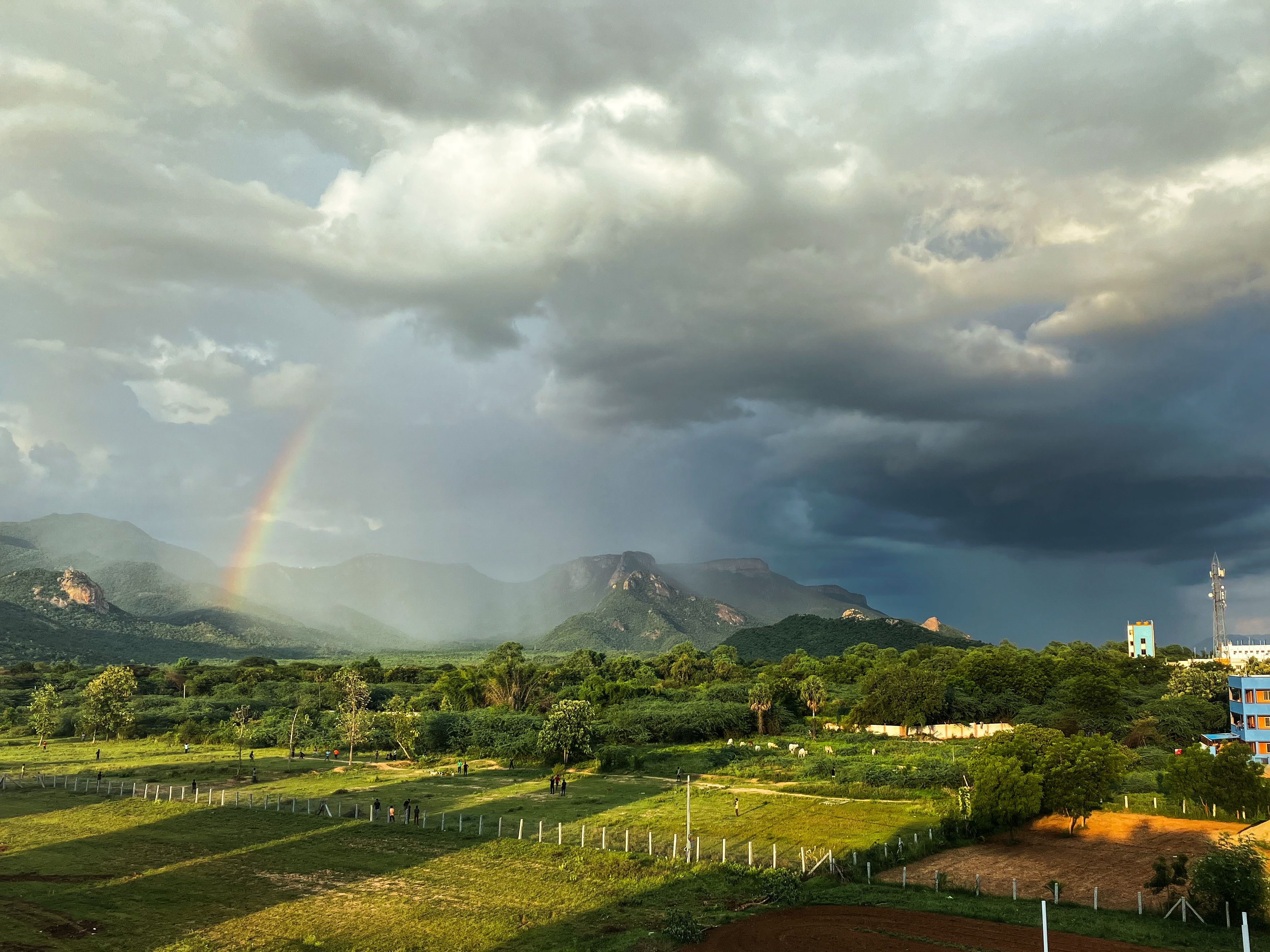 Dramatic Rainbow Over Lush Green Landscape · Free Stock Photo