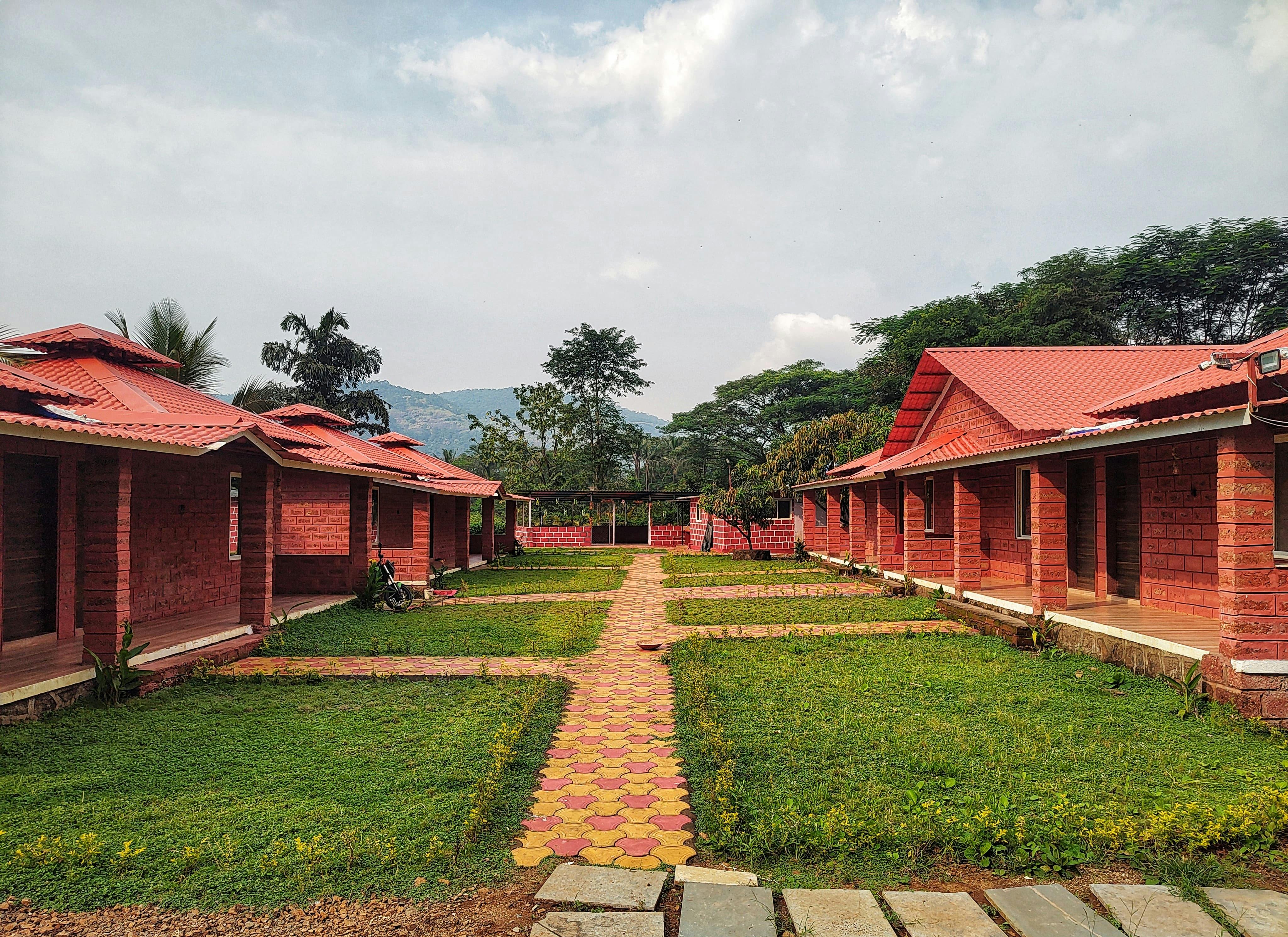 Charming Red Brick Bungalows in Serene Garden Setting · Free Stock Photo