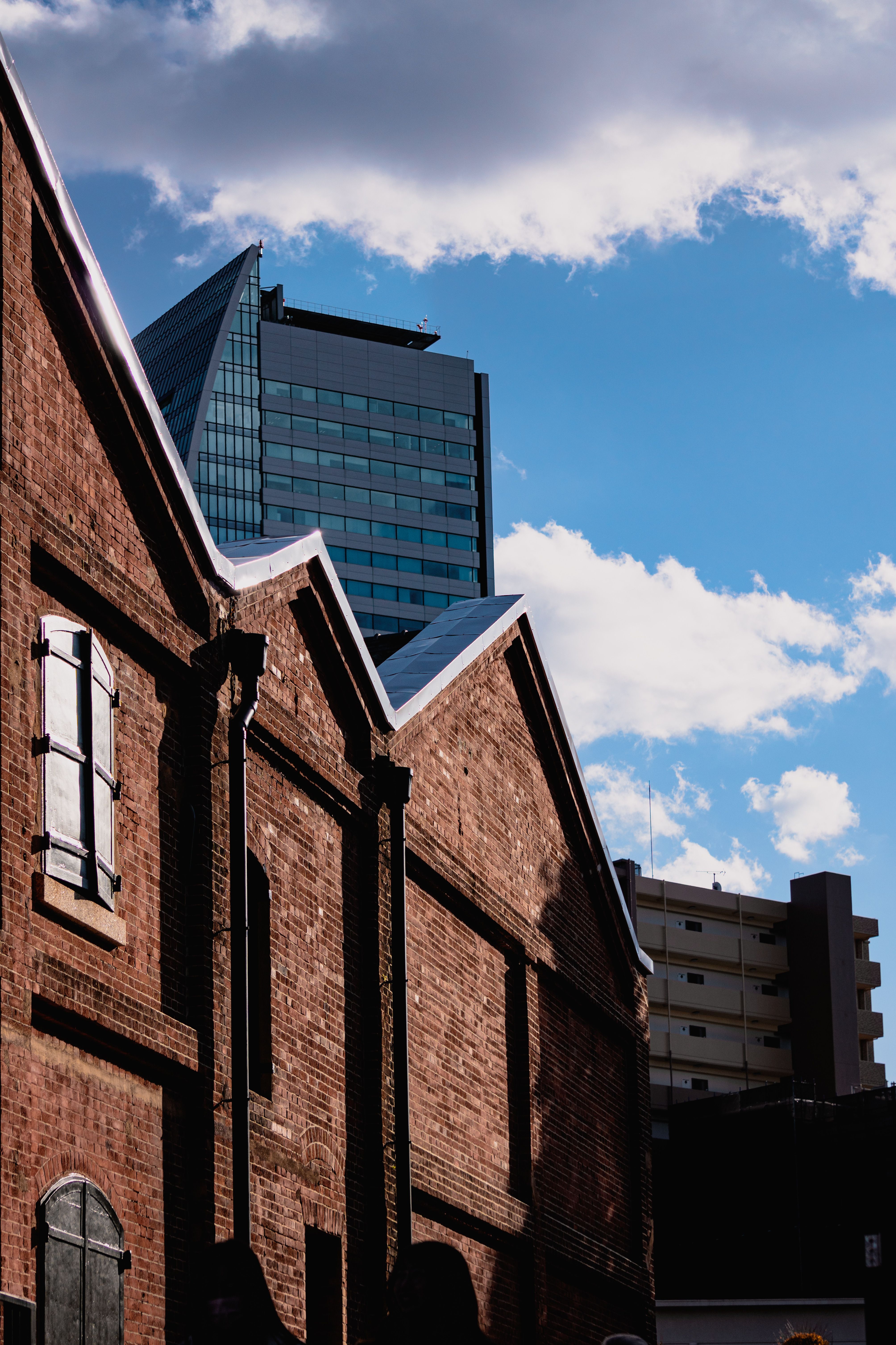 Historic Brick Building with Modern Skyscraper Backdrop · Free Stock Photo