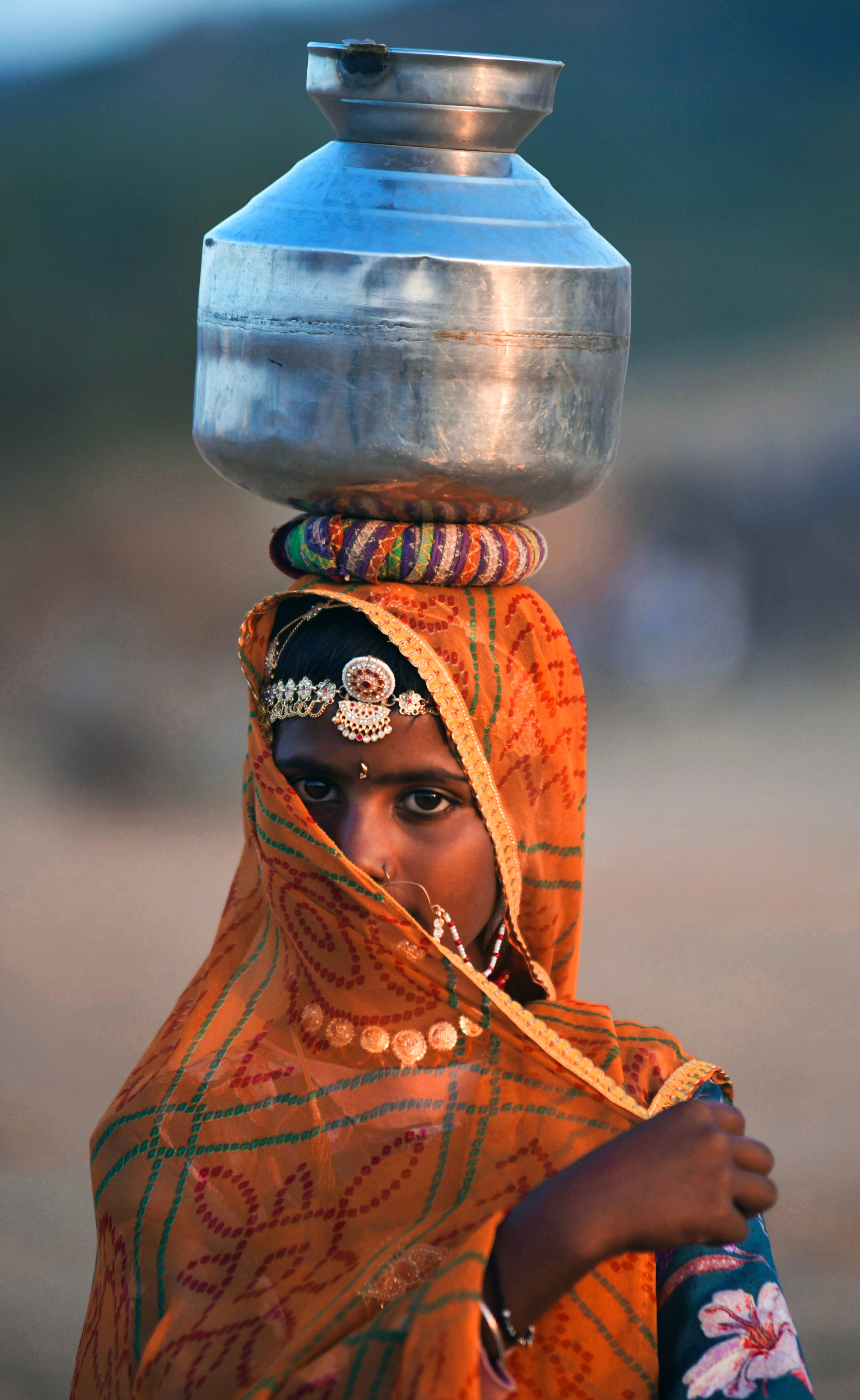 Young woman carrying water pot in traditional attire · Free Stock Photo