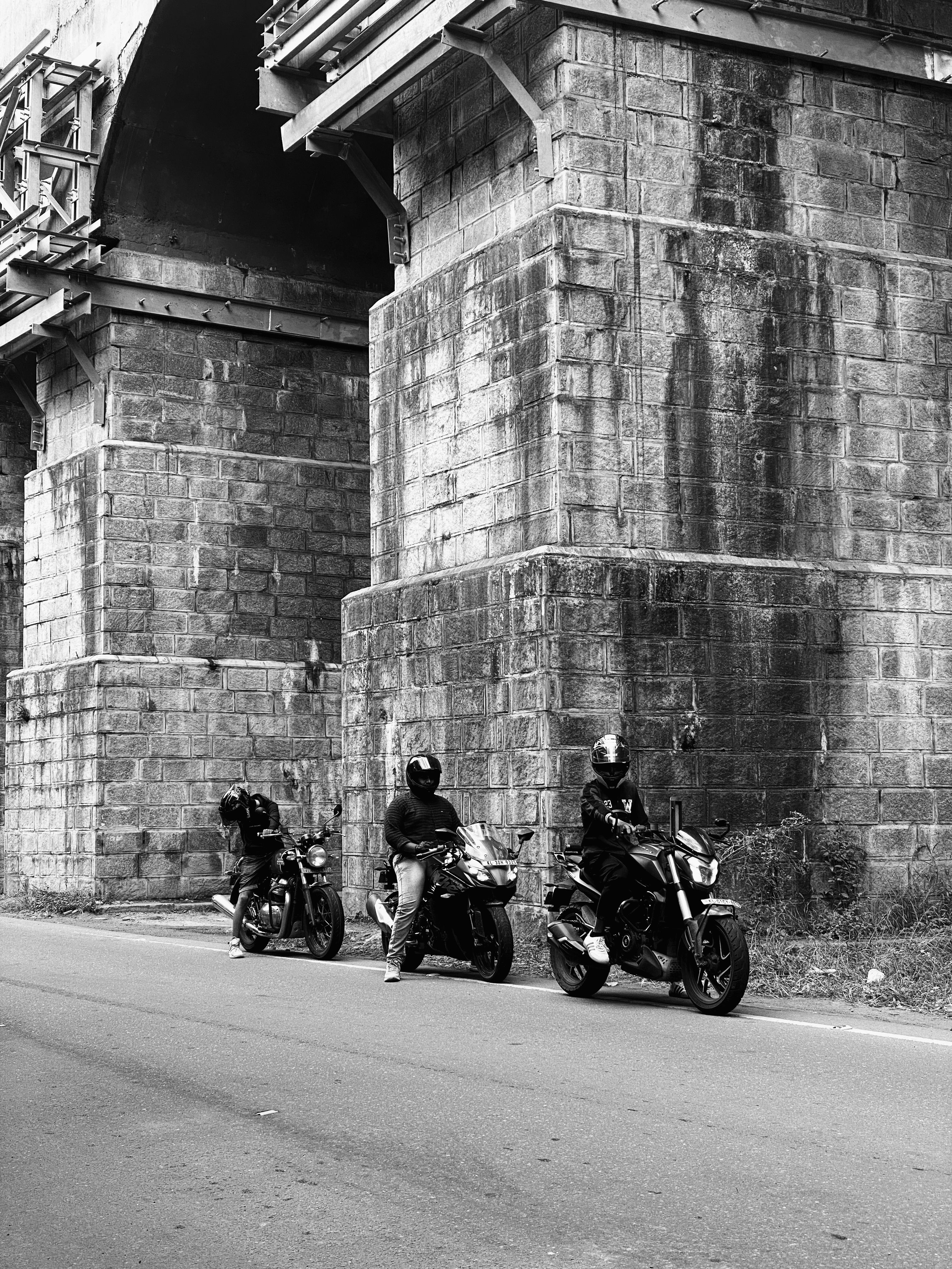Urban Adventure Riders Under Stone Bridge · Free Stock Photo