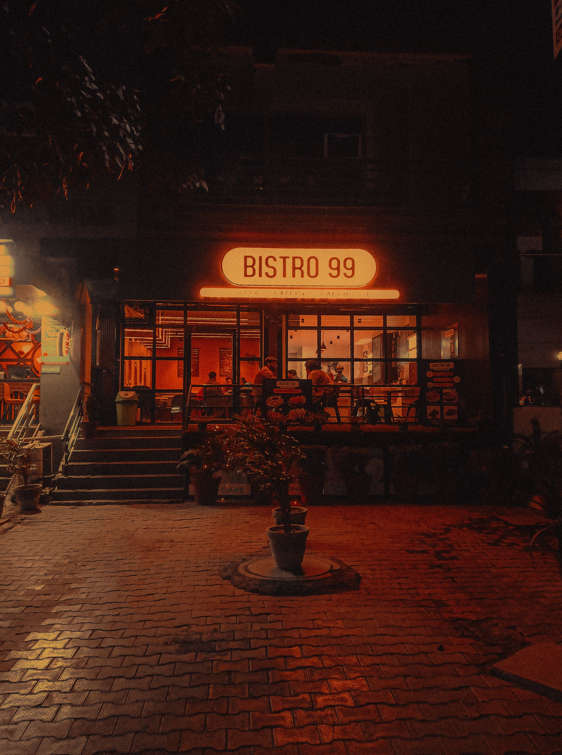 Cozy Night Scene at Bistro 99 Entrance · Free Stock Photo
