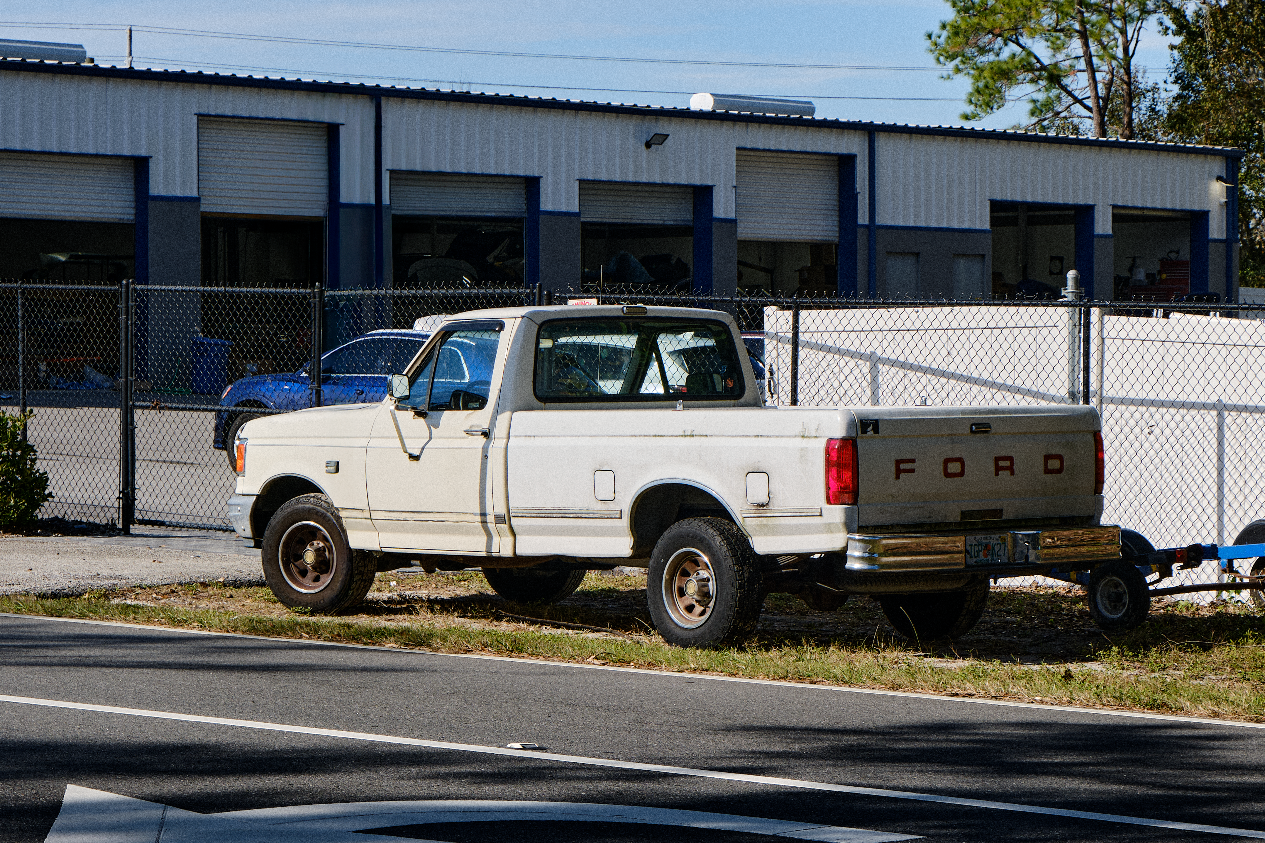 Old White Pickup Truck Parked Outside Garage · Free Stock Photo
