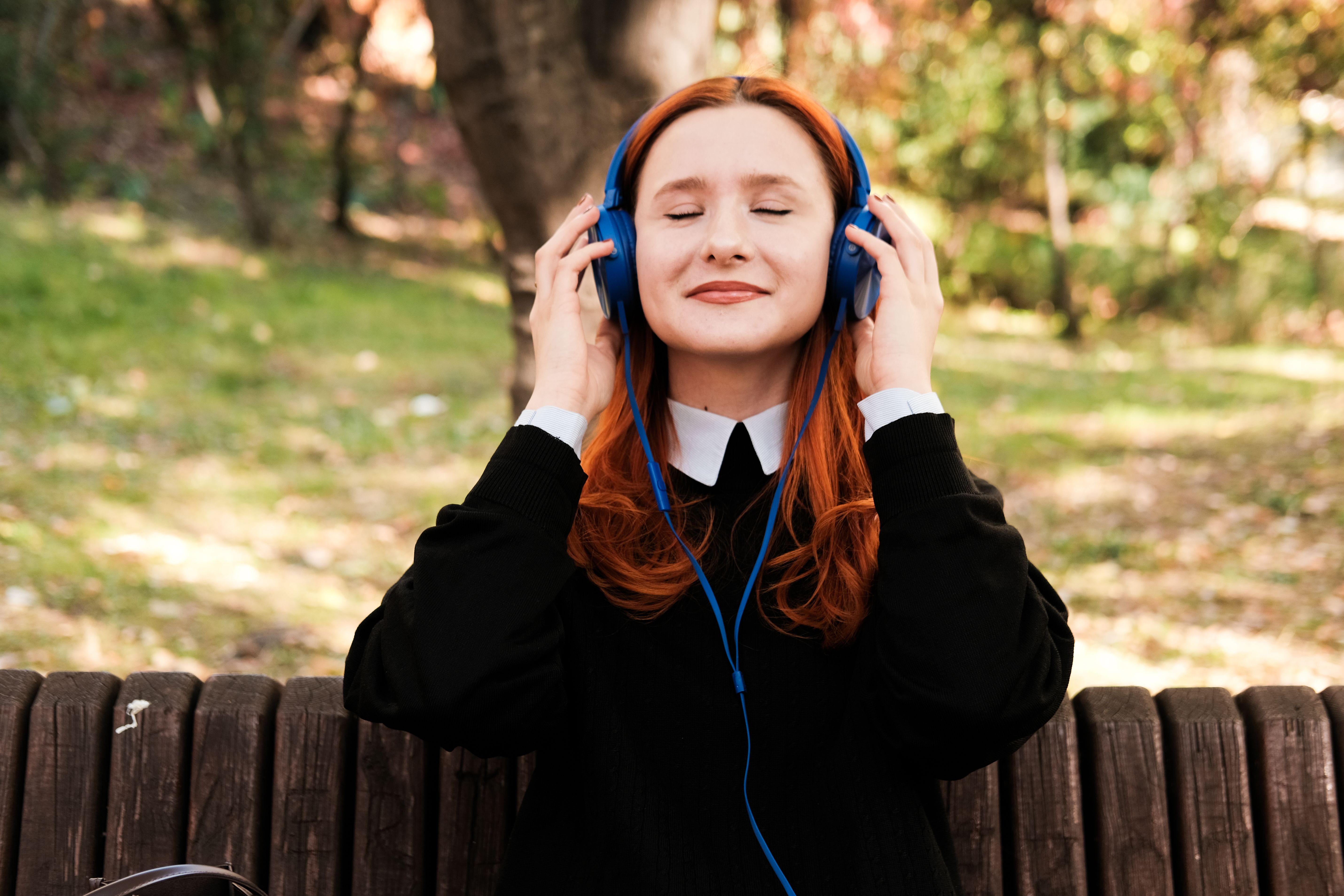Relaxed Woman Listening to Music Outdoors · Free Stock Photo