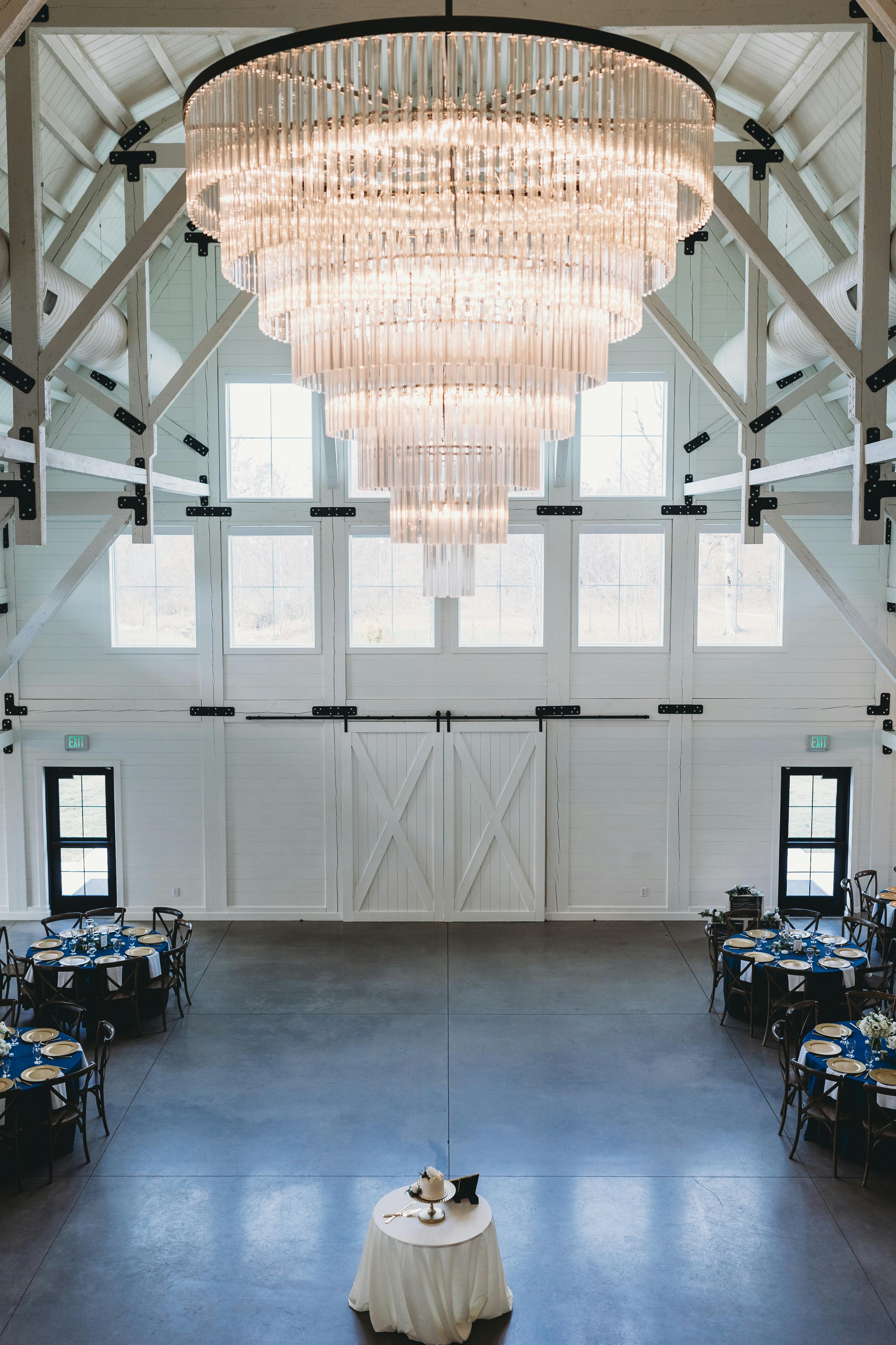 Elegant Barn Wedding Venue Interior with Chandelier · Free Stock Photo