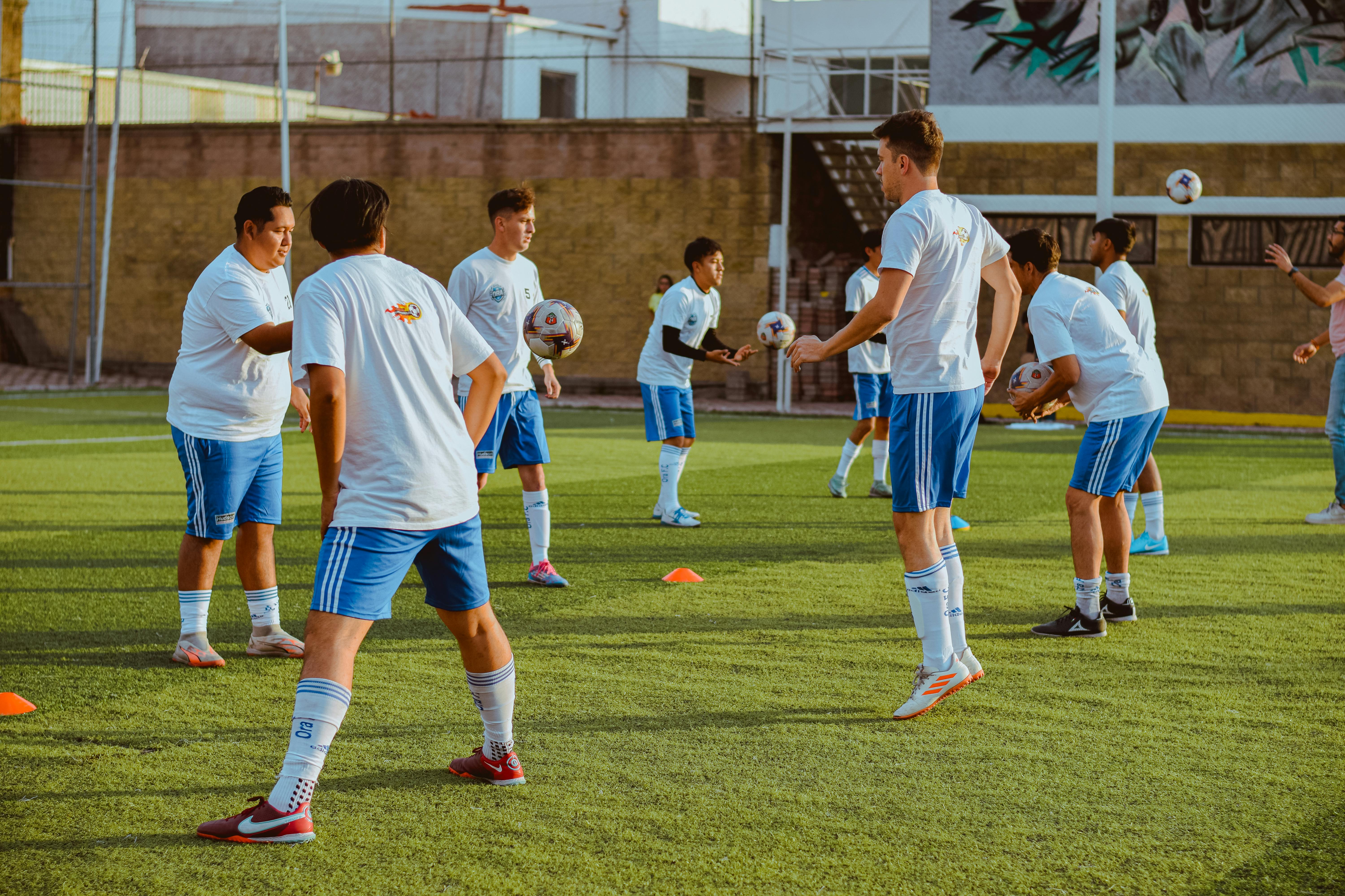 Youth Soccer Team Practicing on Field · Free Stock Photo