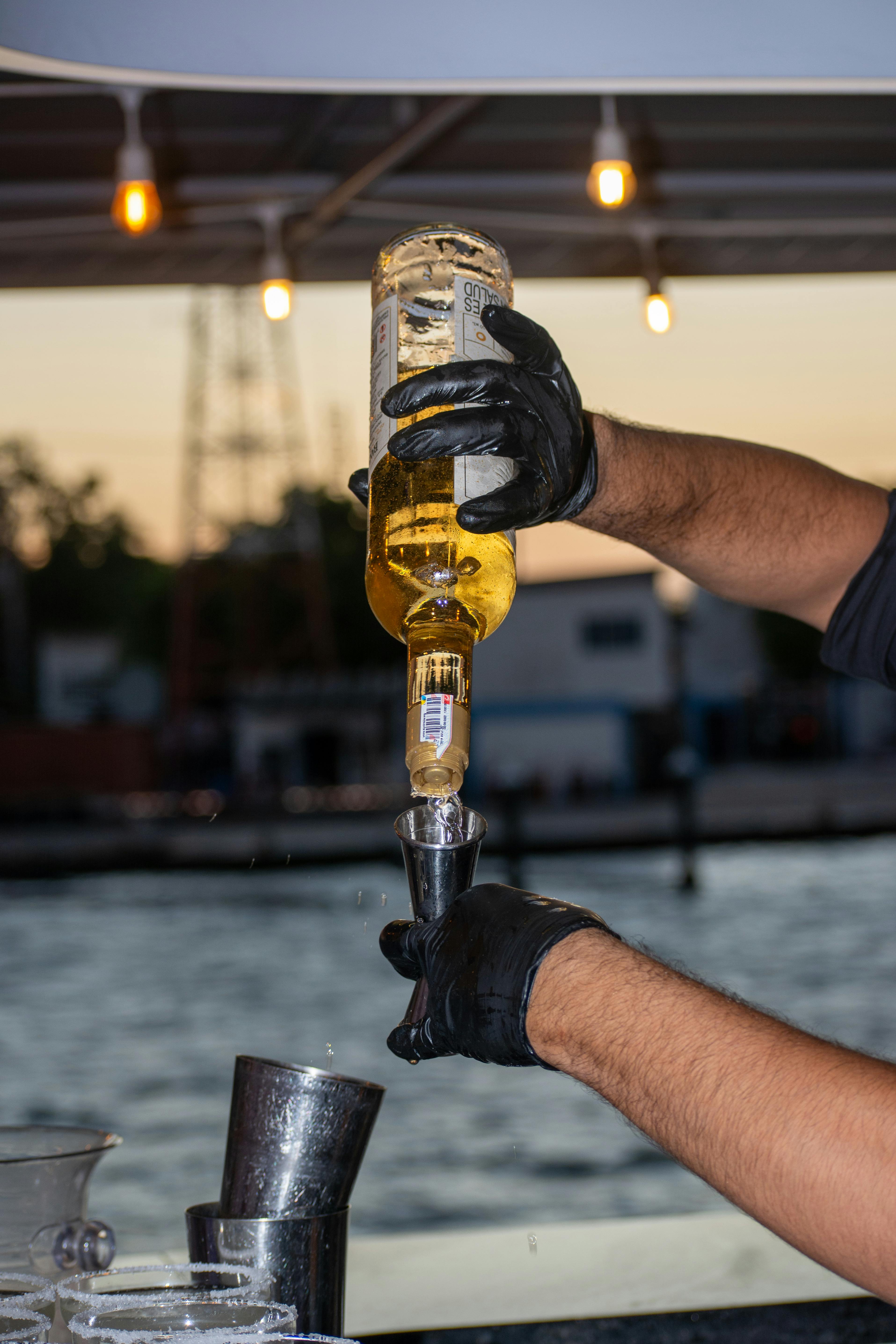 Bartender Pouring Beer at Outdoor Bar during Sunset · Free Stock Photo