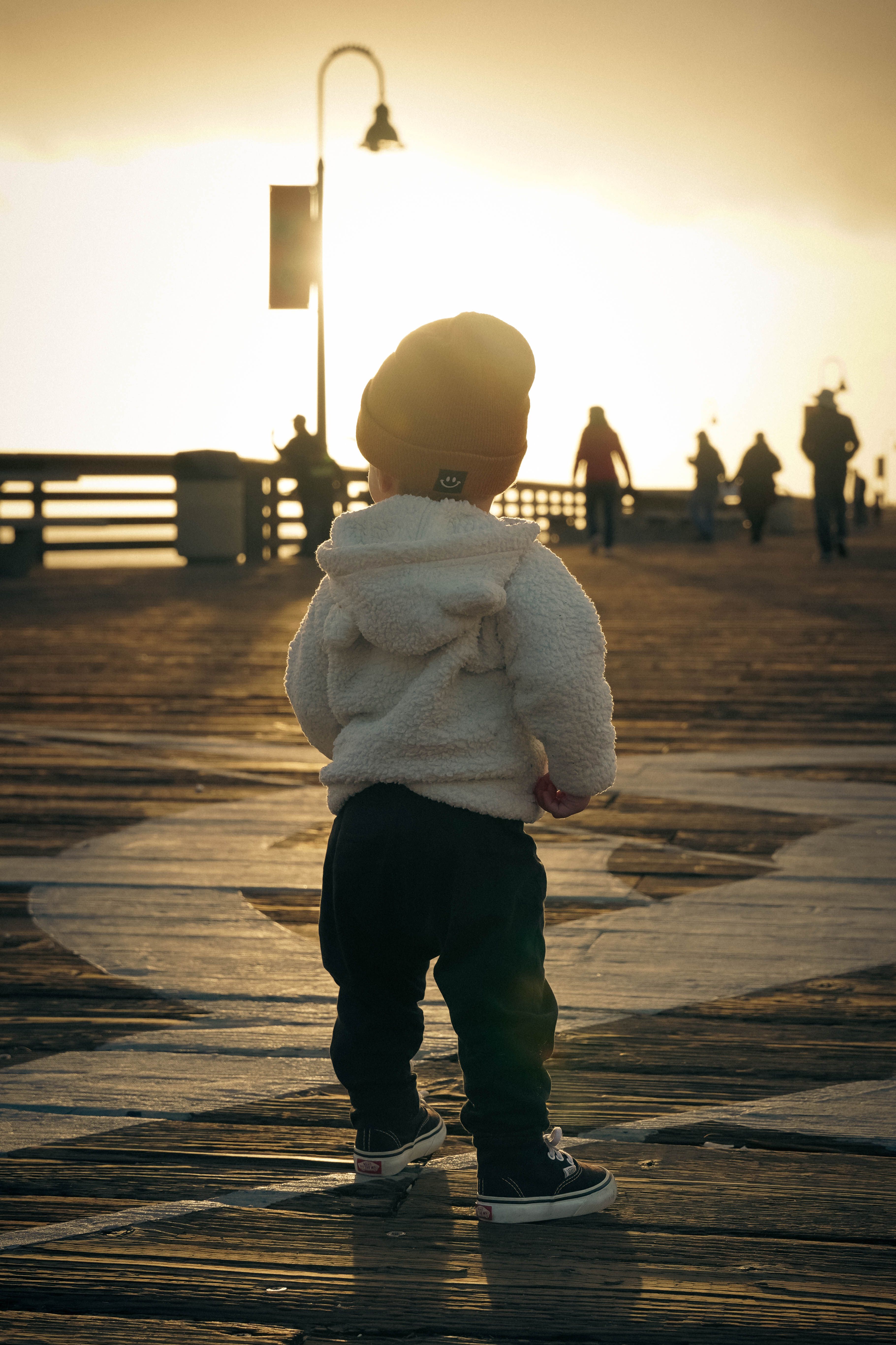 Child Watching Sunset on Pismo Beach Pier · Free Stock Photo