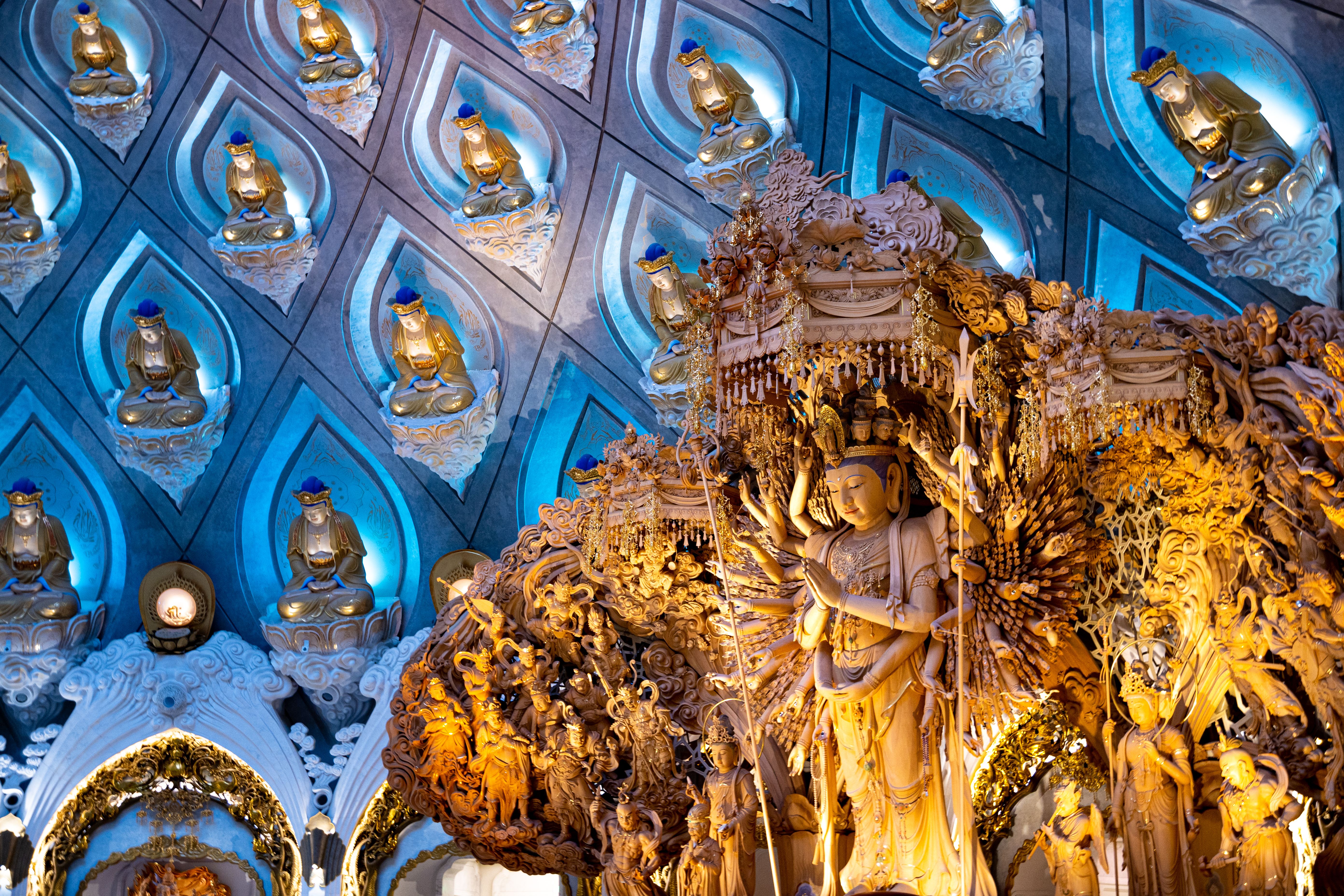 Intricate Golden Buddhist Temple Statues Display · Free Stock Photo