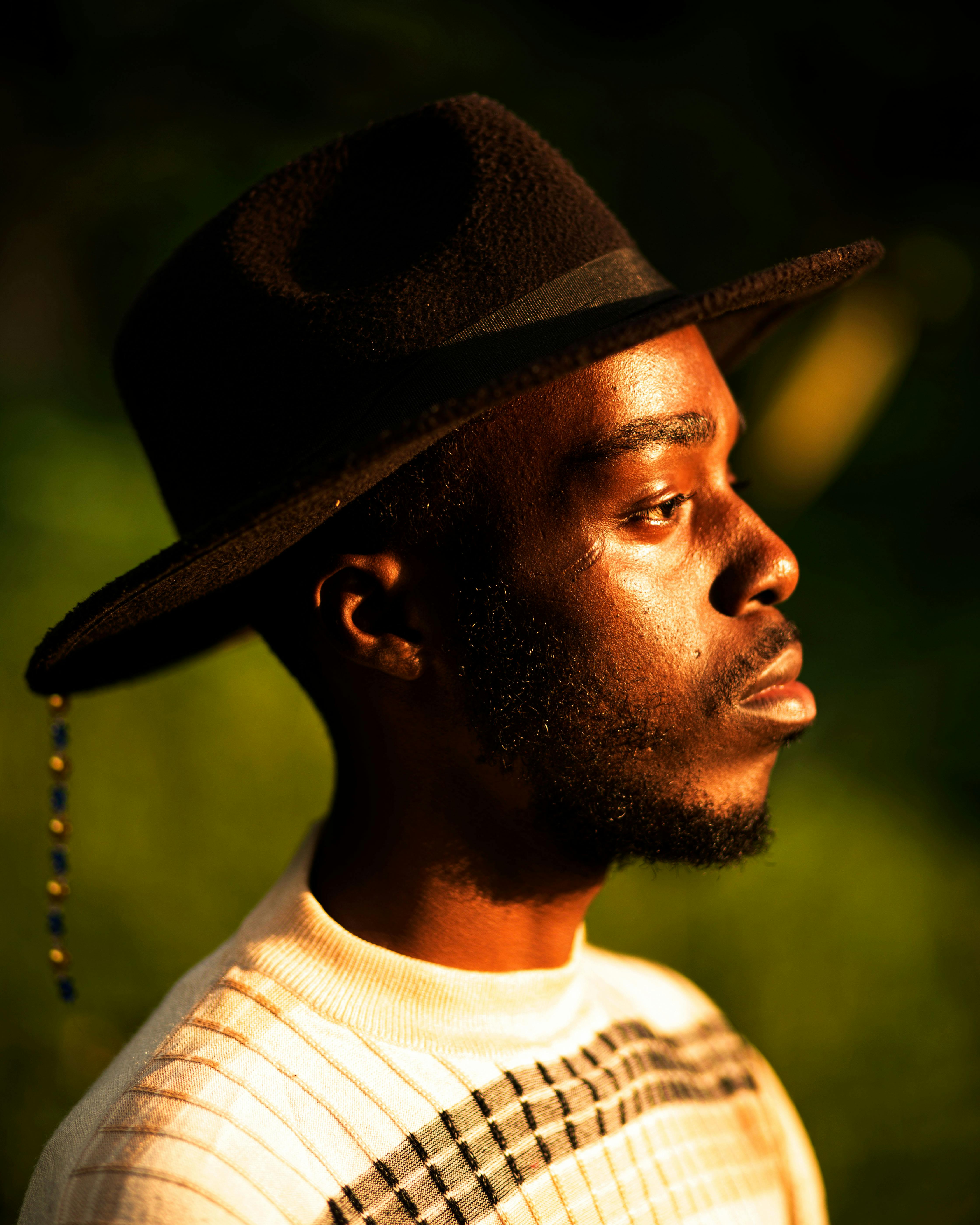 Portrait of a Man in Hat with Sunlit Background · Free Stock Photo