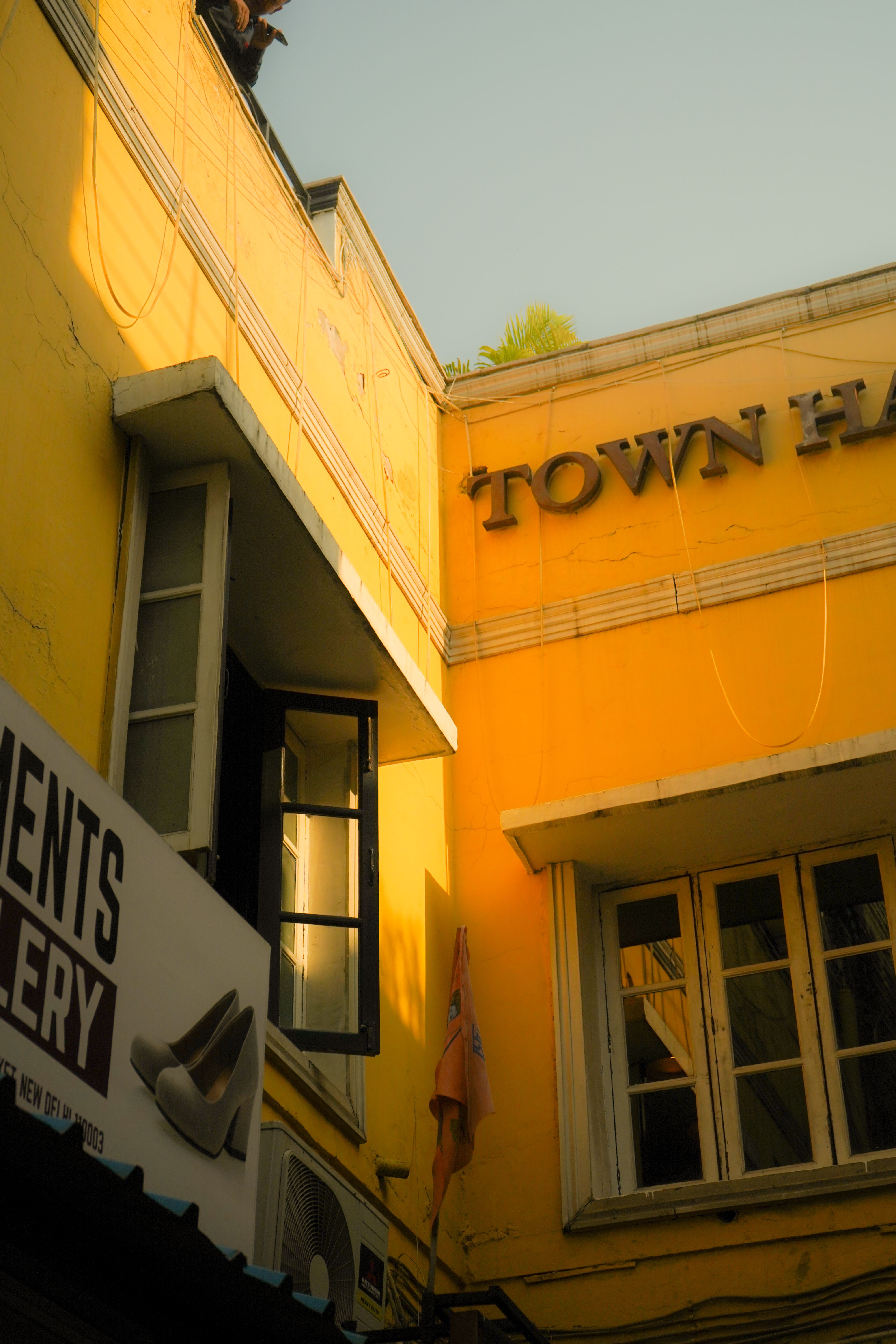 Yellow Building Facade with Town Hall Sign · Free Stock Photo