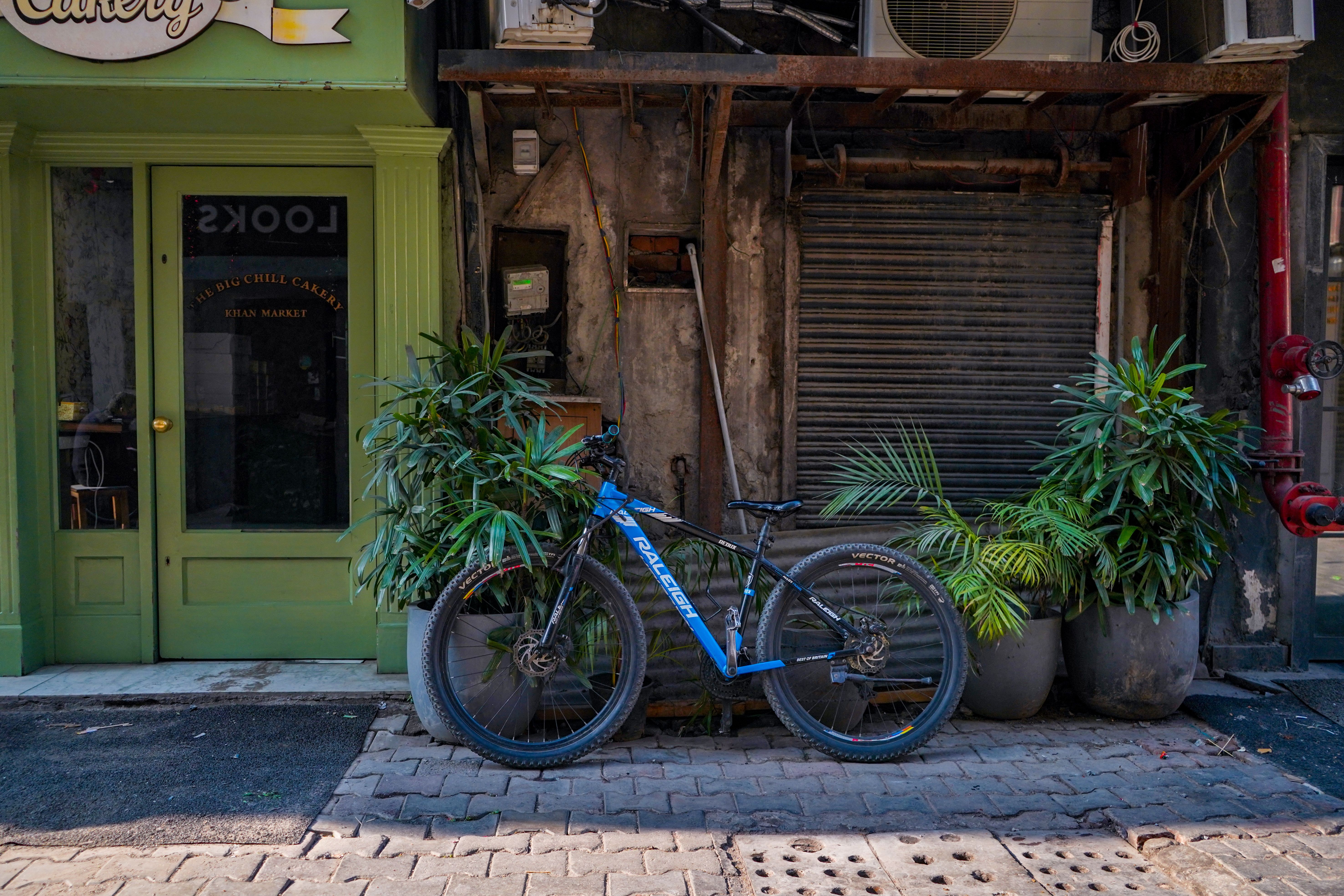 Bicycle Parked Outside Urban Cafe Entrance · Free Stock Photo