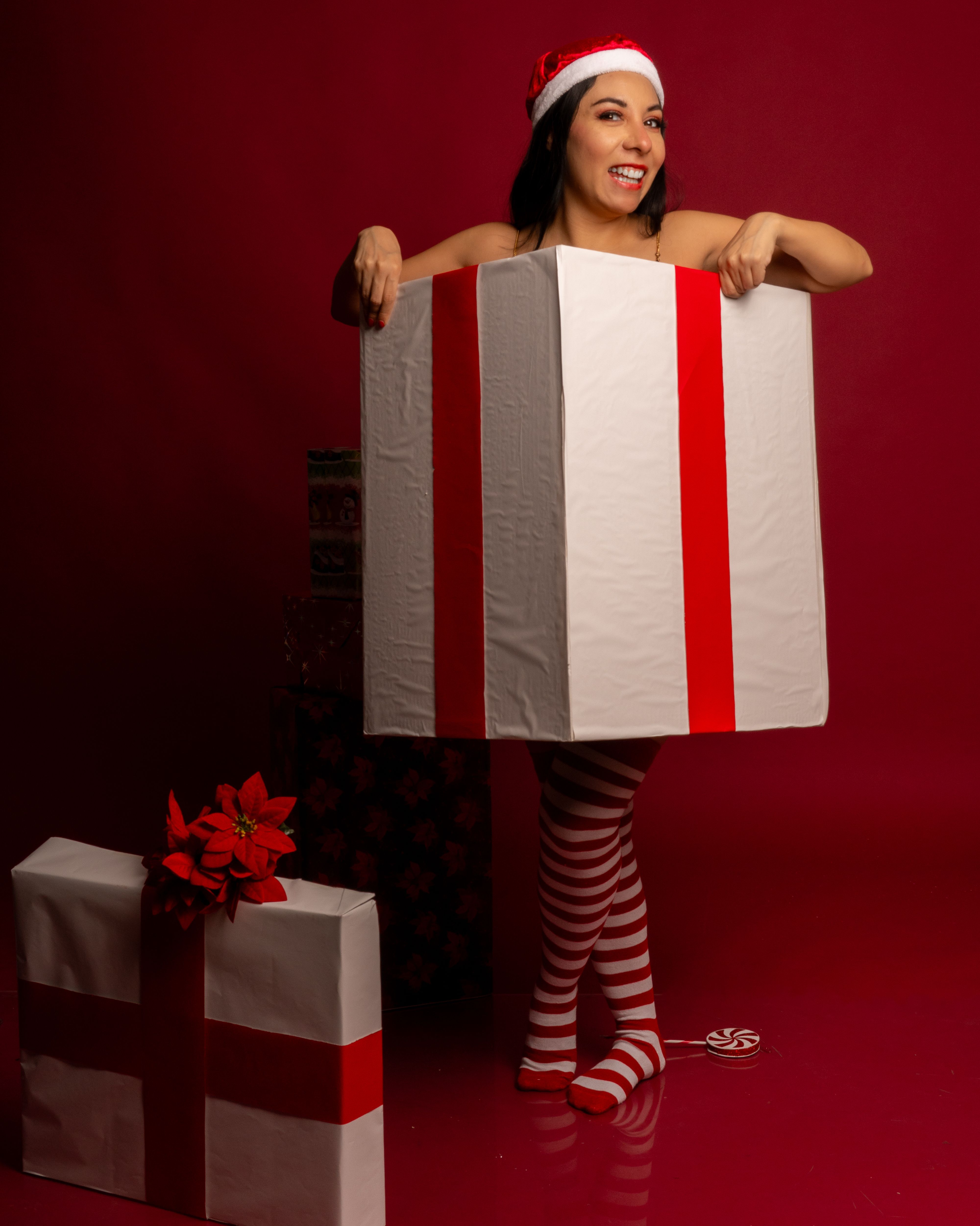 Festive Woman in Gift Box Costume Celebrates Christmas · Free Stock Photo