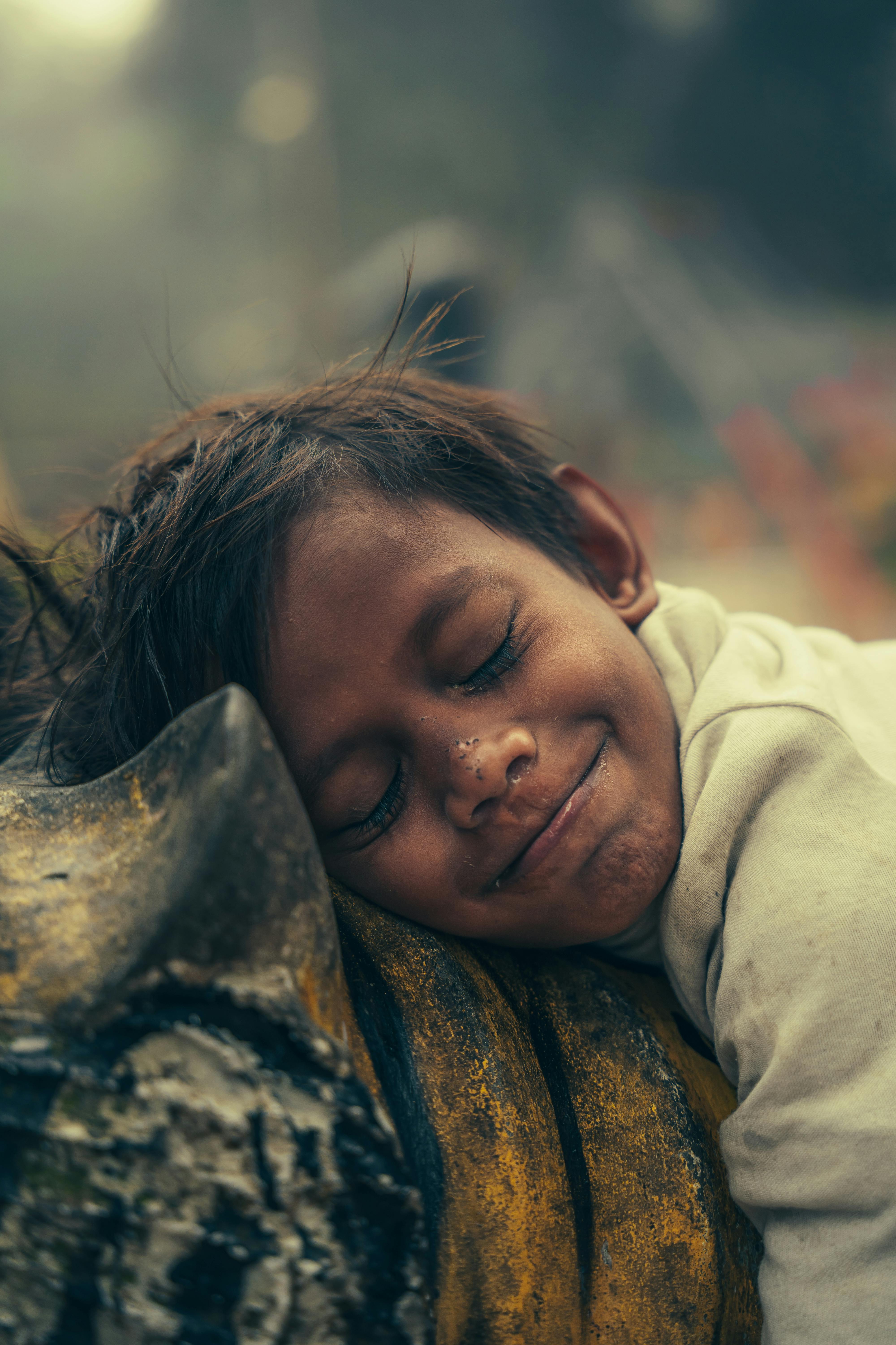Peaceful Child Resting Outdoors in Comilla · Free Stock Photo