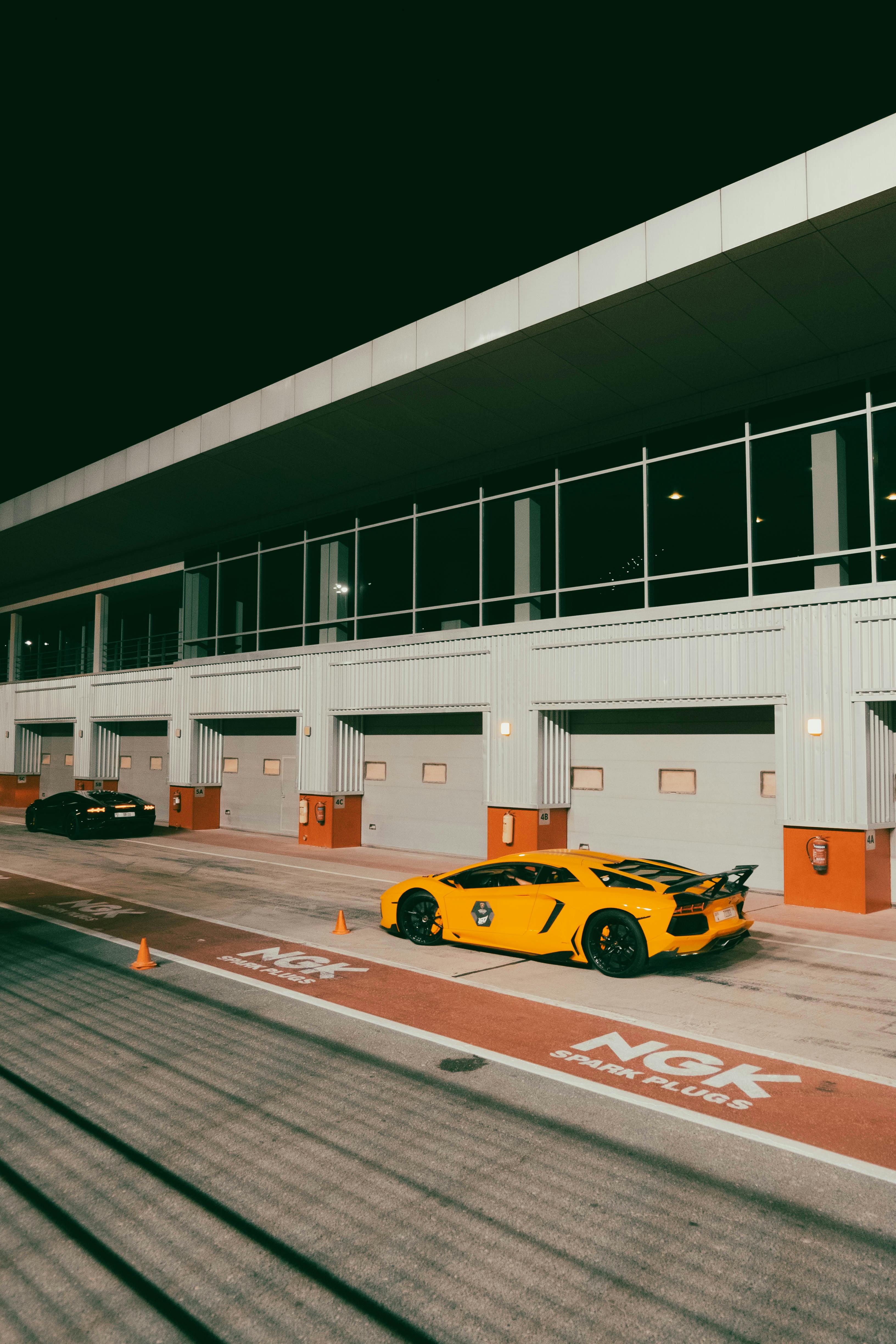 Nighttime Luxury Sports Car at Dubai Racing Track · Free Stock Photo