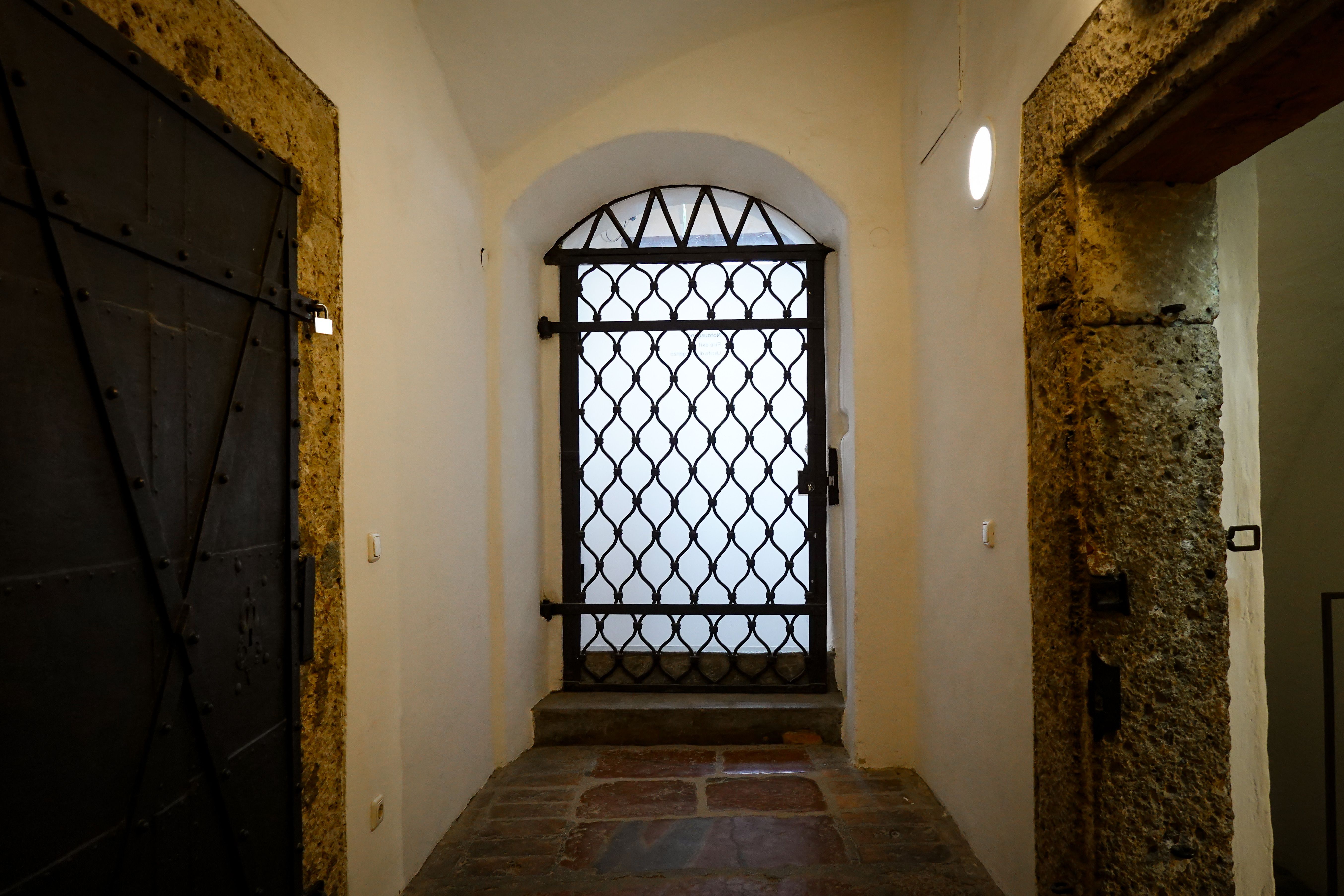 Stone Corridor with Steel Window Grilles · Free Stock Photo