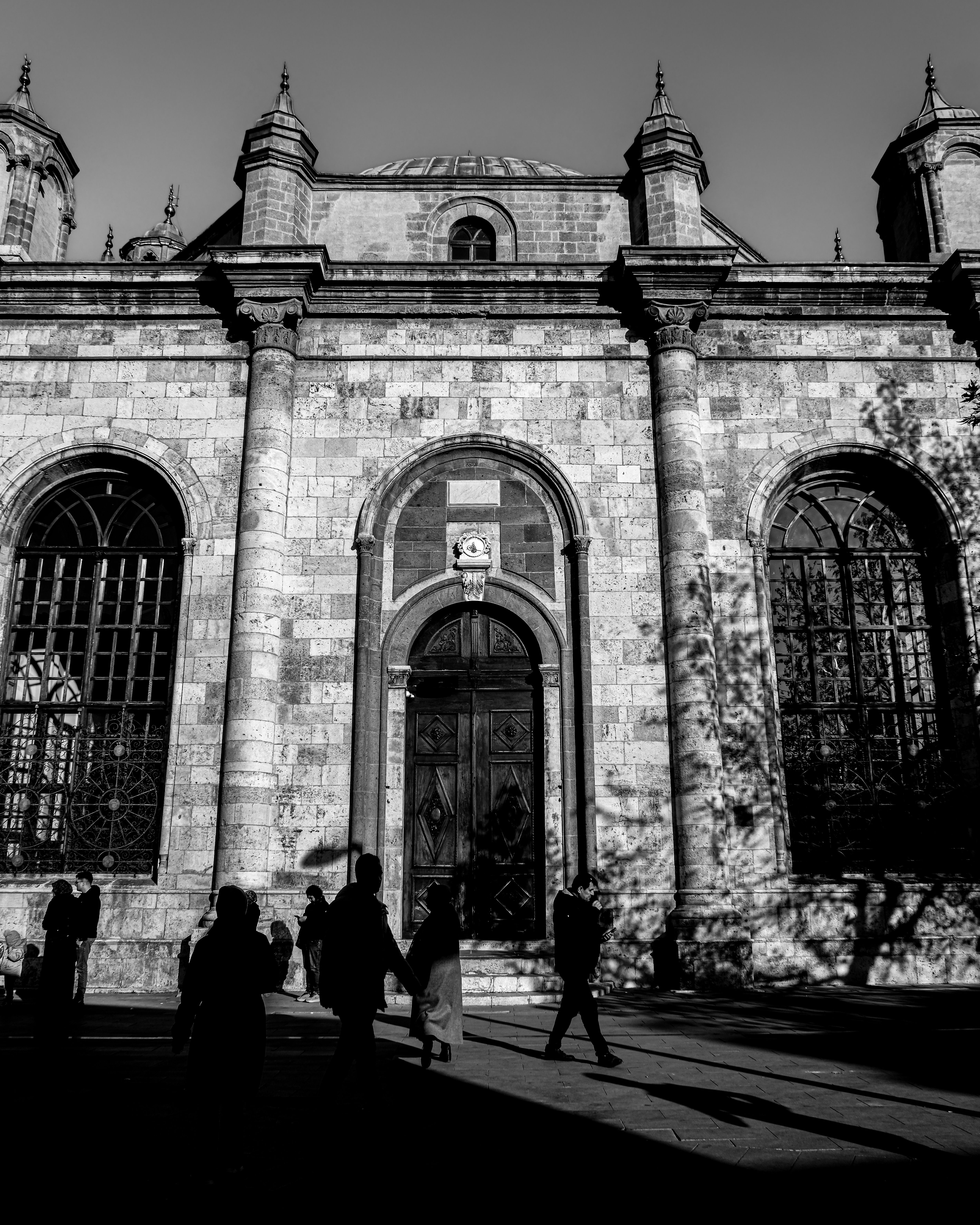 Historic Stone Building with People Shadows · Free Stock Photo