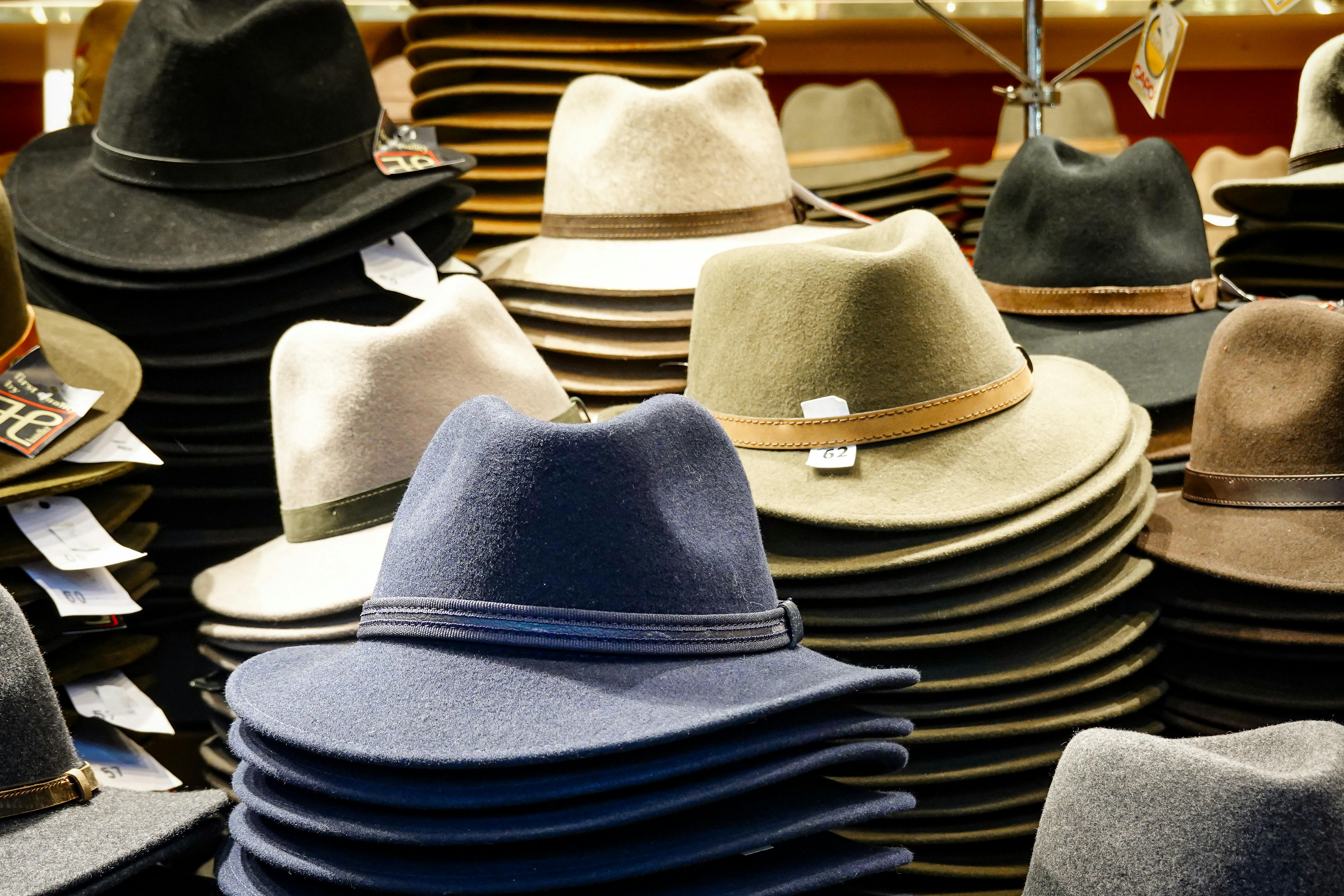 Stack of Fedora Hats on Display in Store · Free Stock Photo