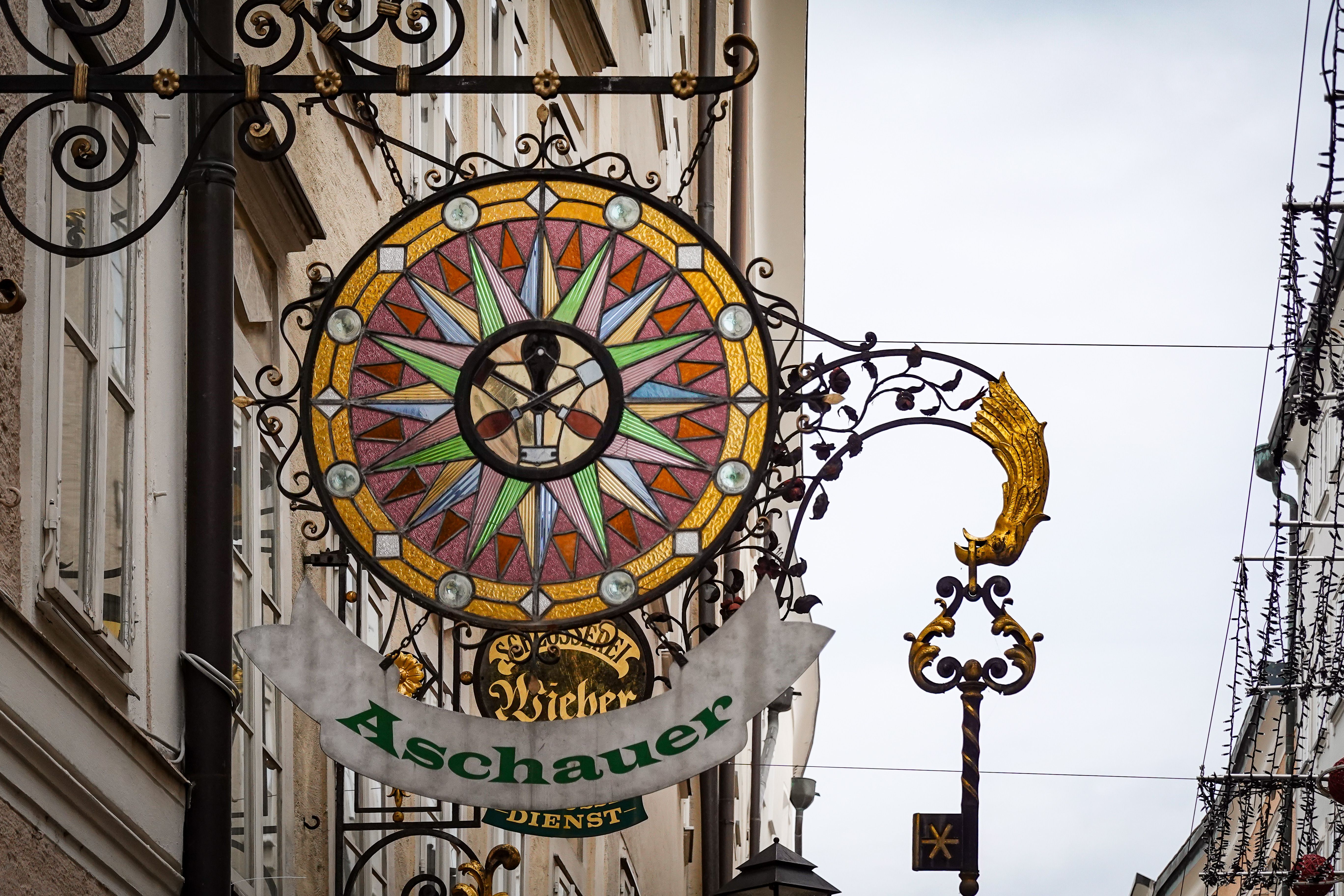 Vintage Metal Sign on a Quaint European Street · Free Stock Photo