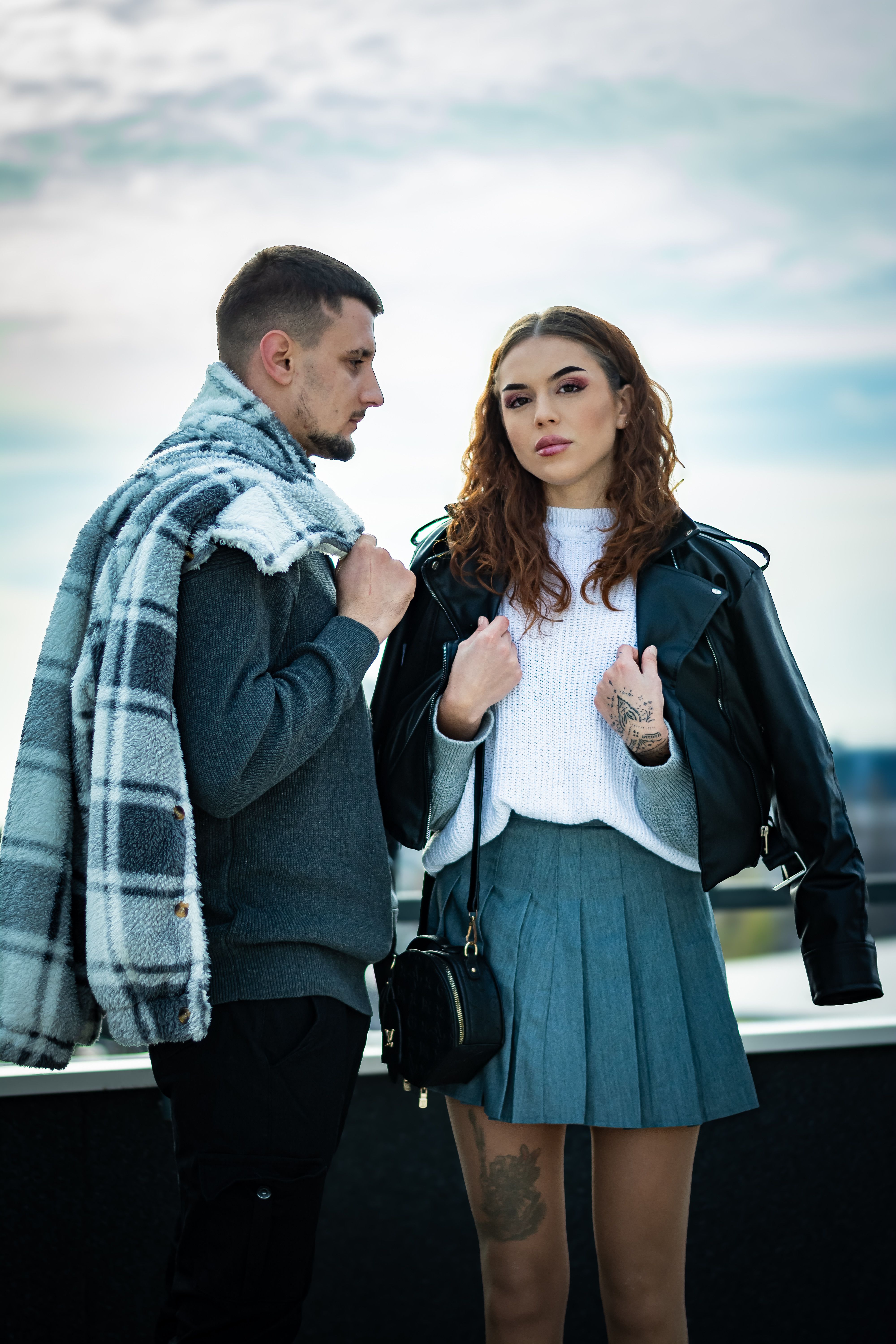Trendy Couple Posing Outdoors in Stylish Outfits · Free Stock Photo