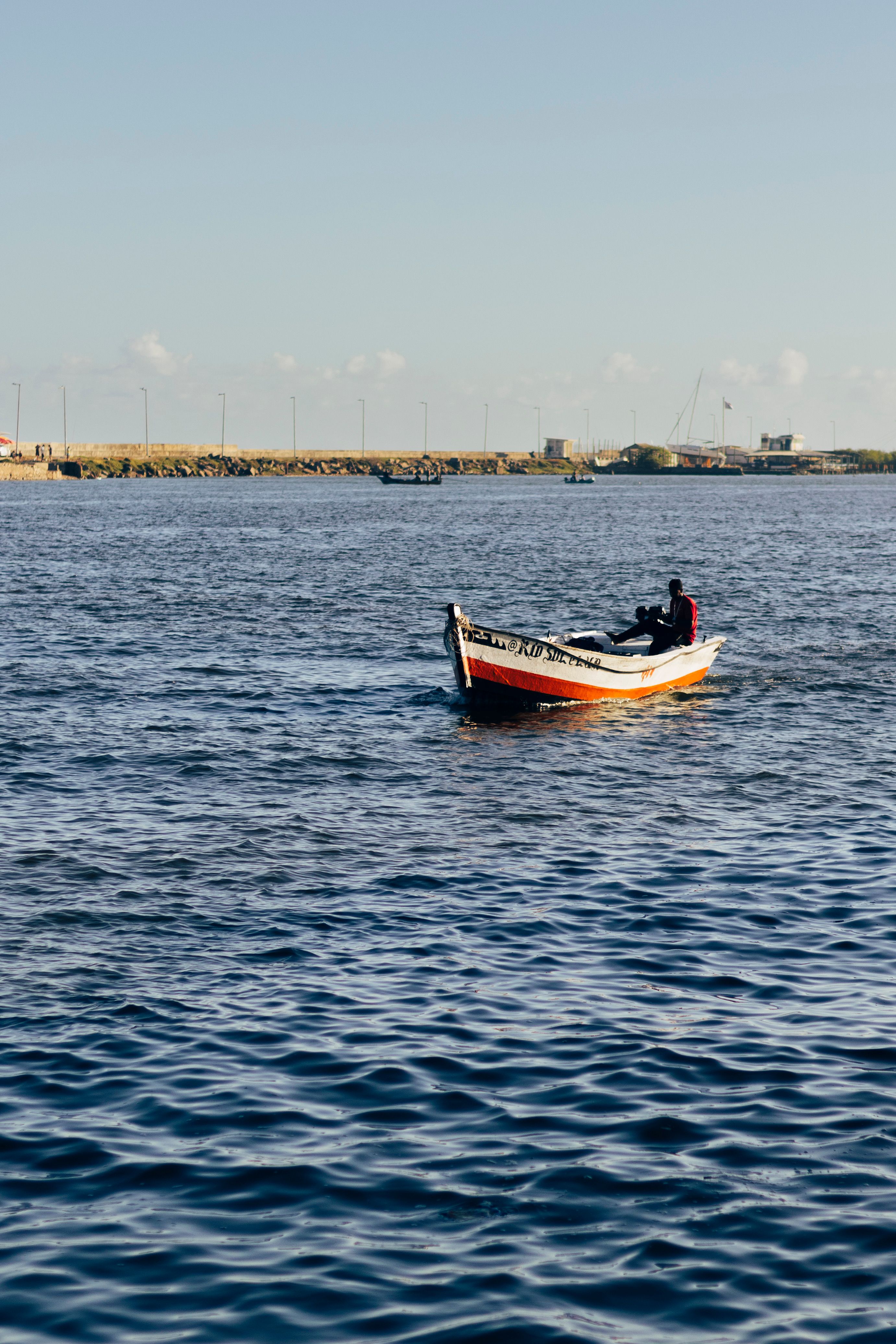 Small Fishing Boat on Calm Coastal Waters · Free Stock Photo
