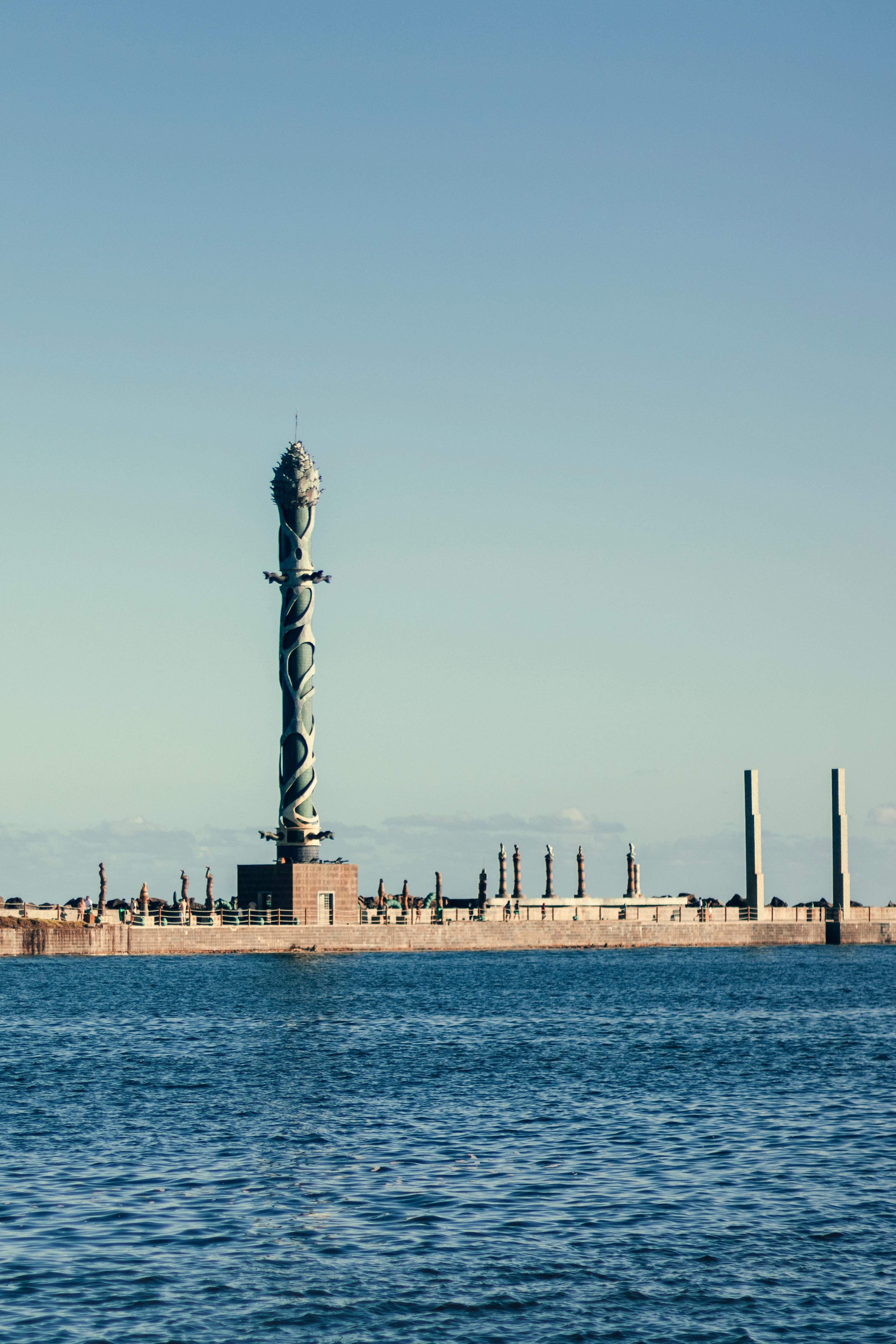 Futuristic Lighthouse by Waterfront View · Free Stock Photo