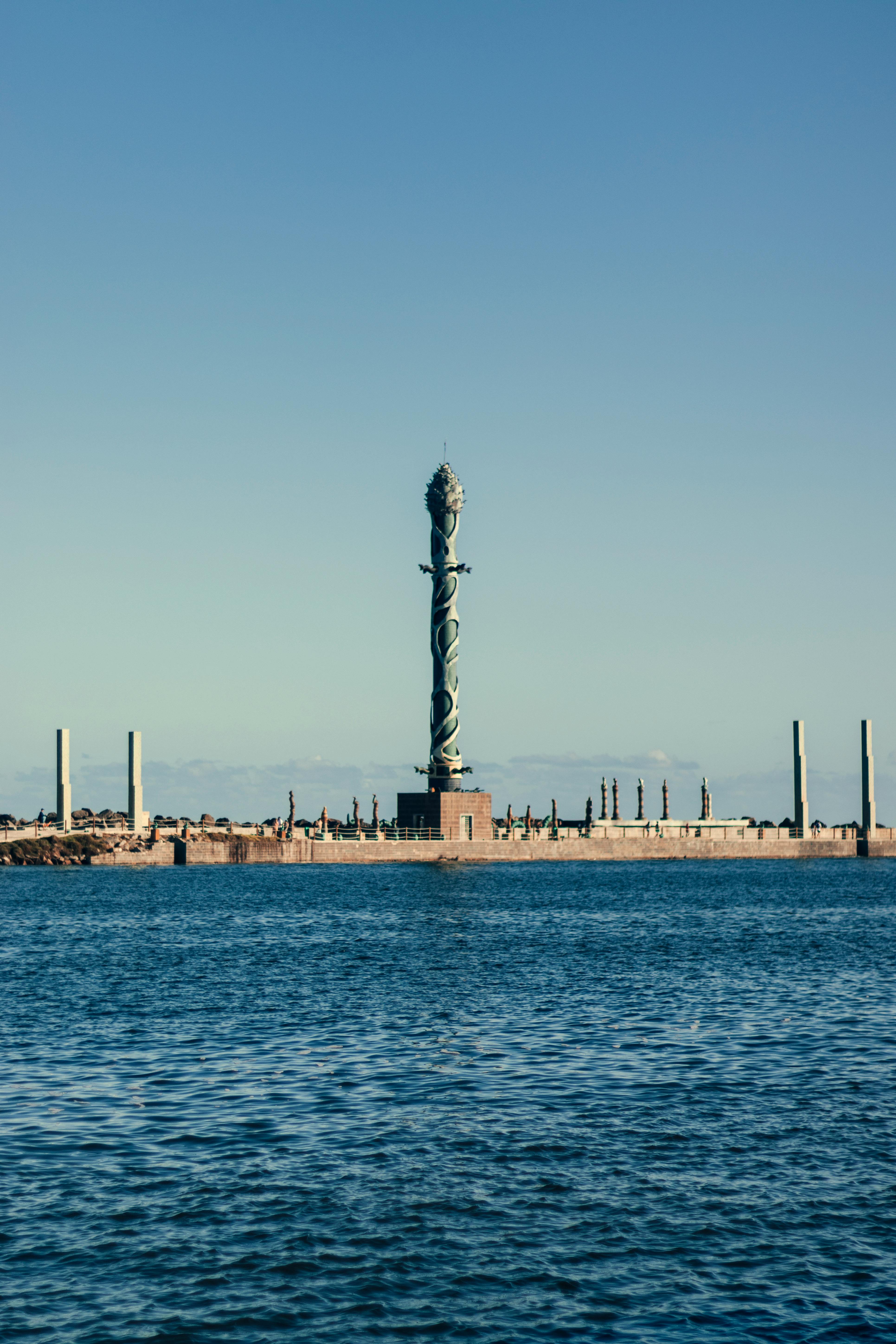 Stunning Monument by Waterfront on Clear Day · Free Stock Photo