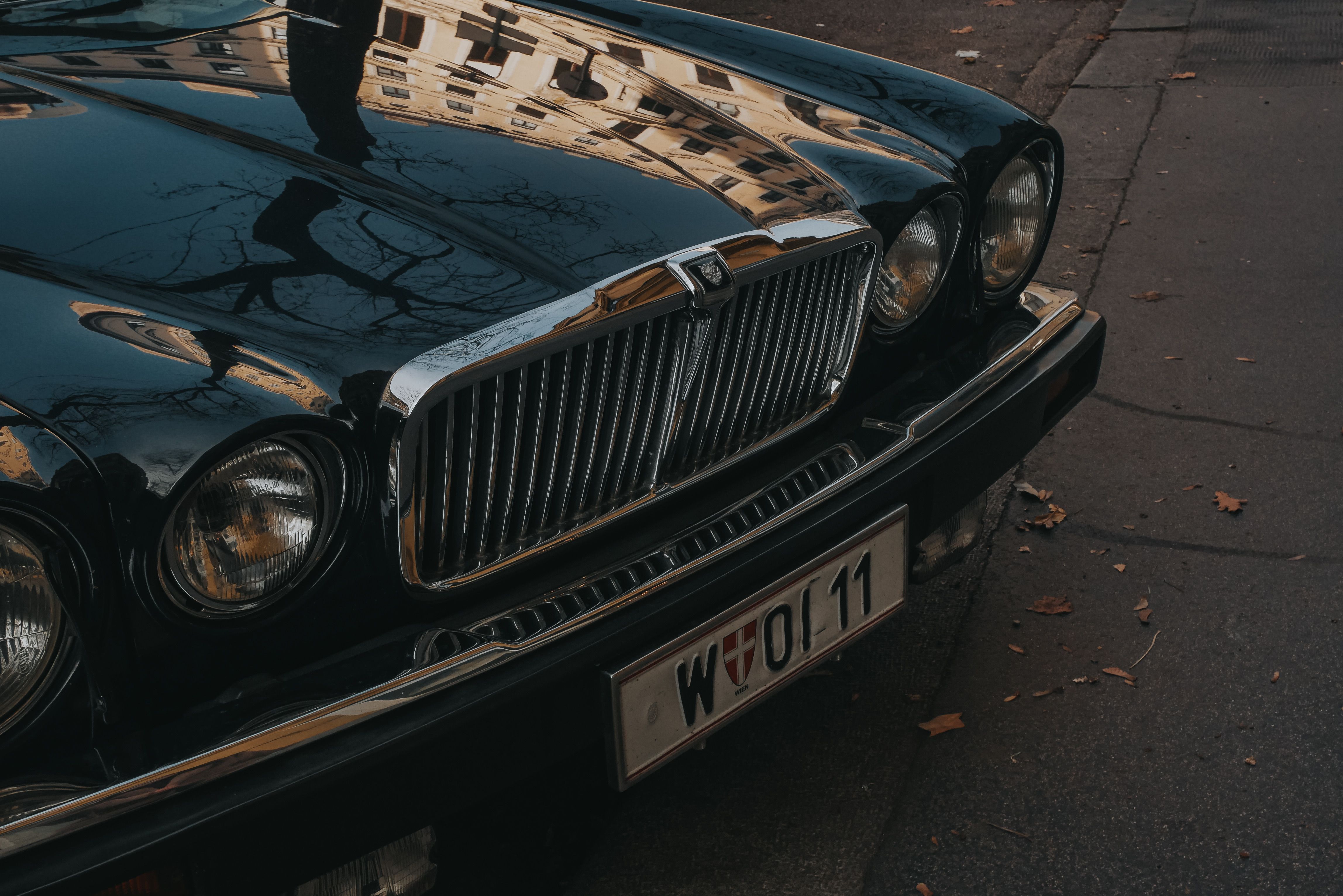 Classic Car with Building Reflection in Urban Setting · Free Stock Photo