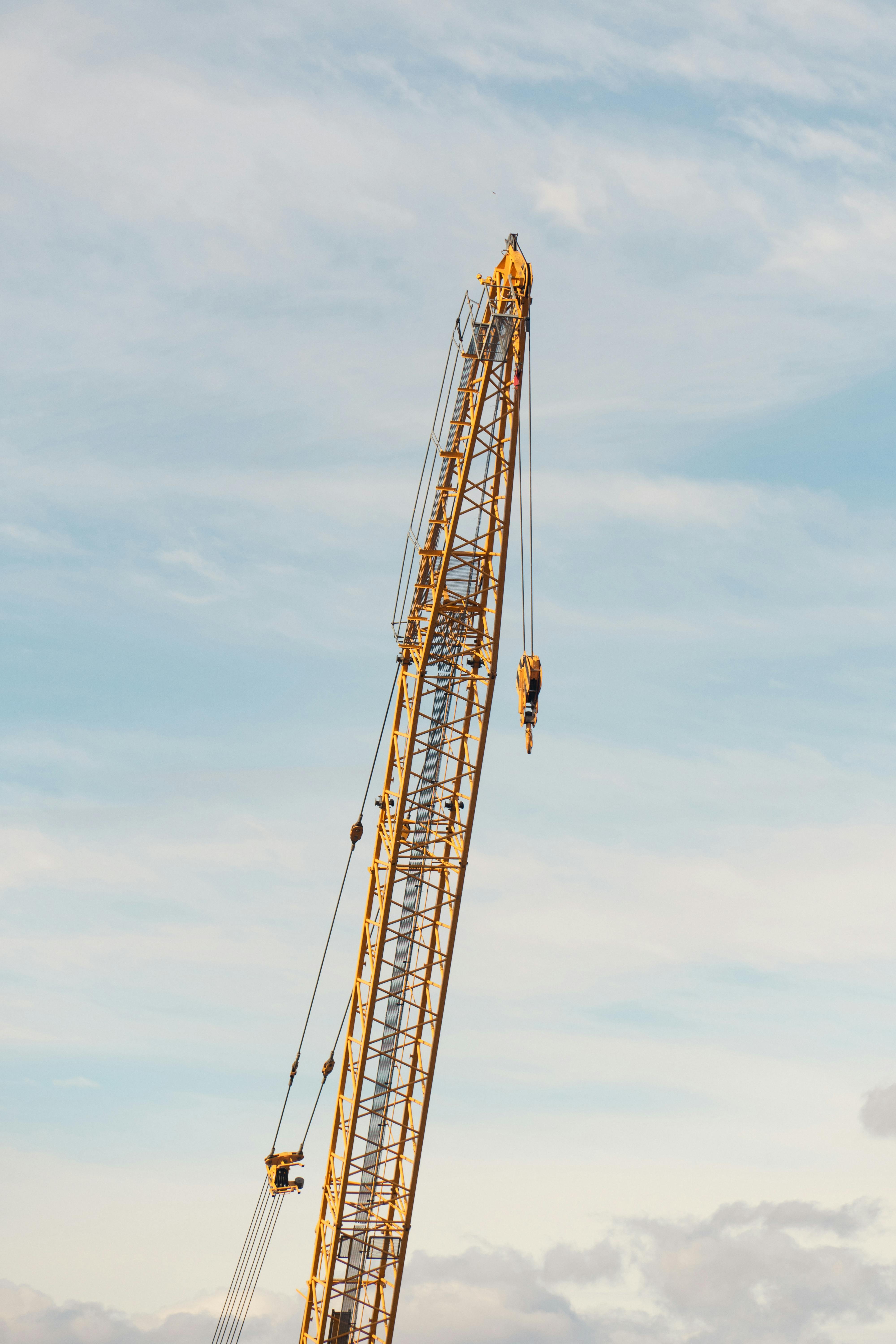 Tower Crane Against Blue Sky on Construction Site · Free Stock Photo