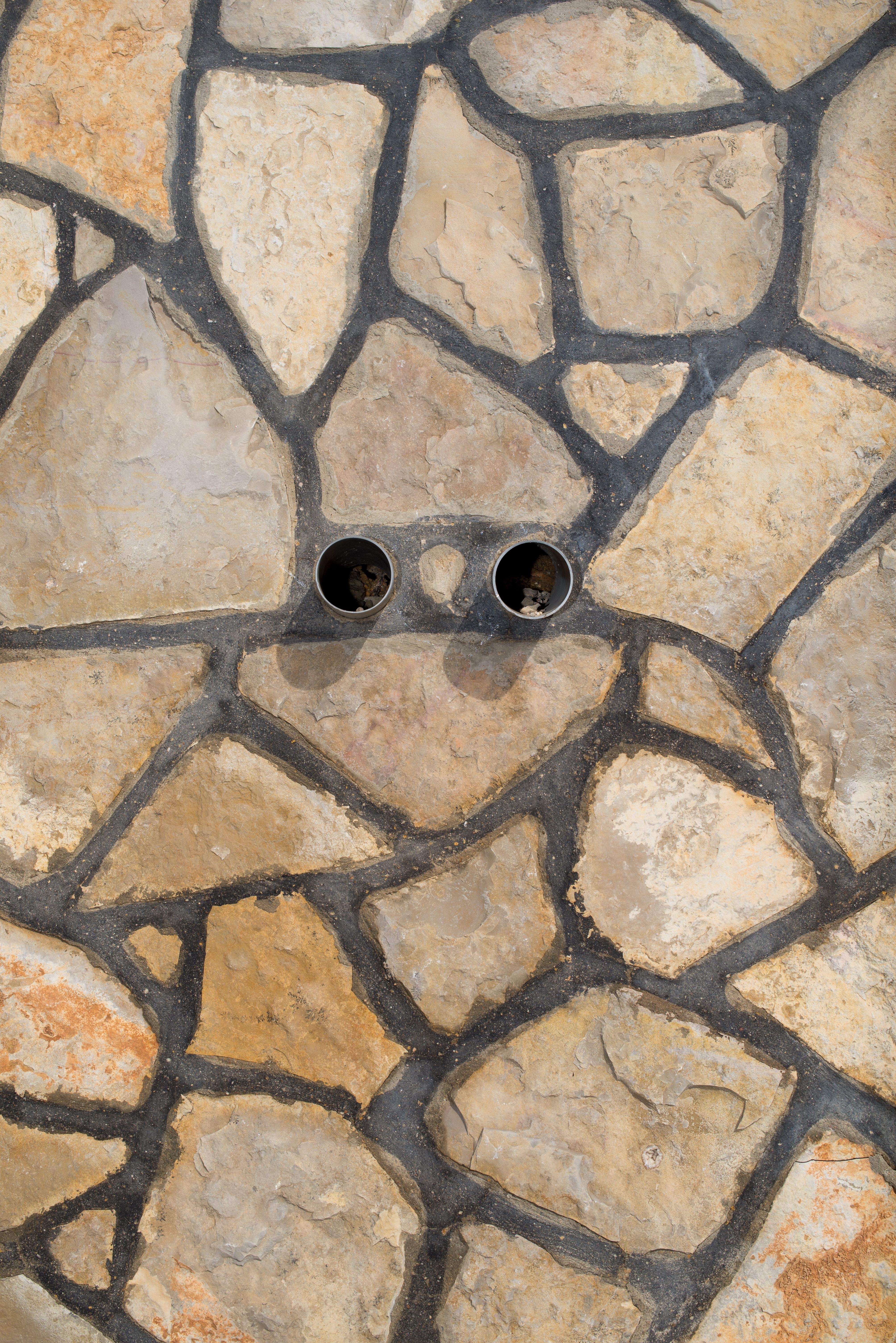 Stone Tiled Surface with Metal Pipes · Free Stock Photo