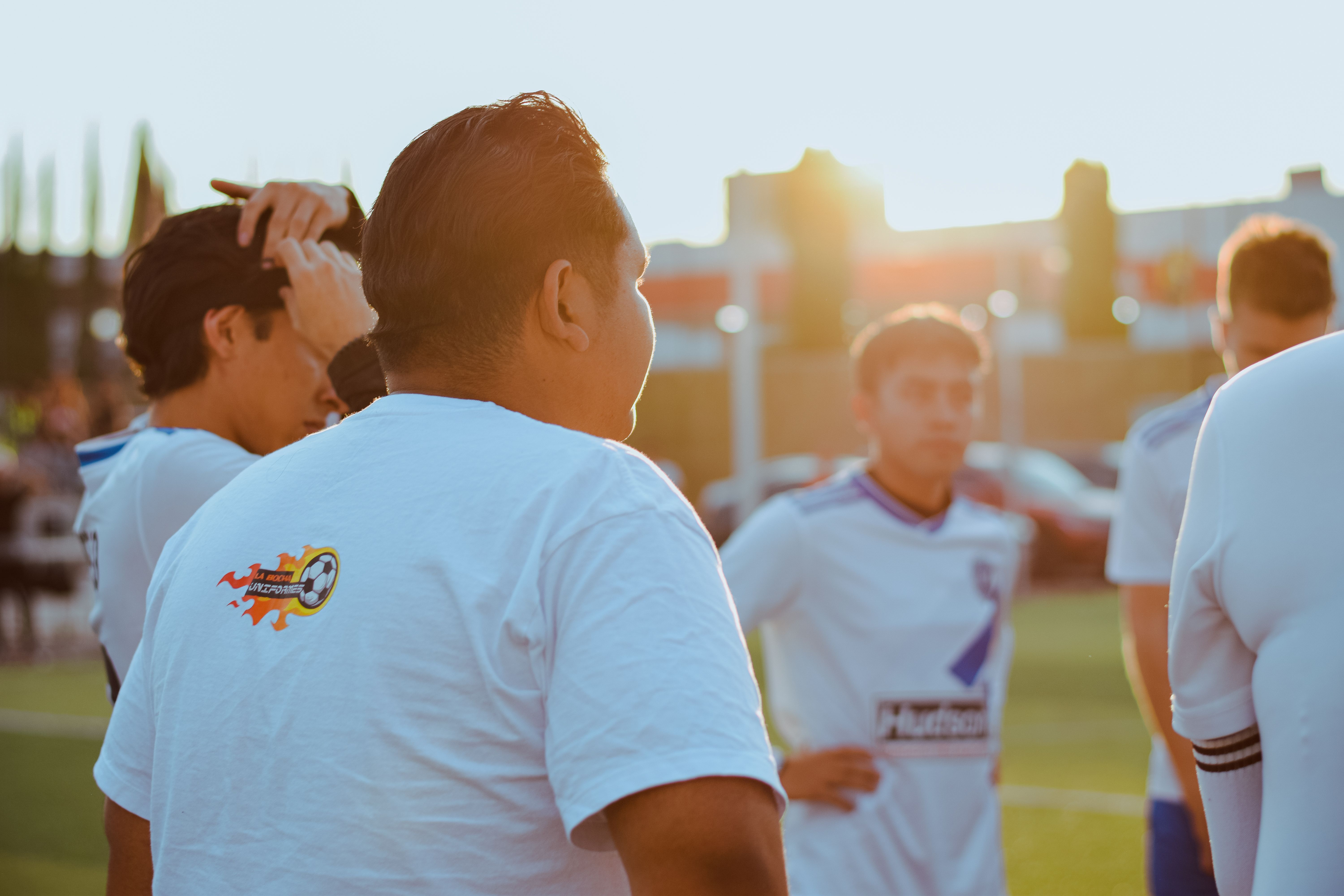 Soccer Team Strategy Meeting at Sunset · Free Stock Photo