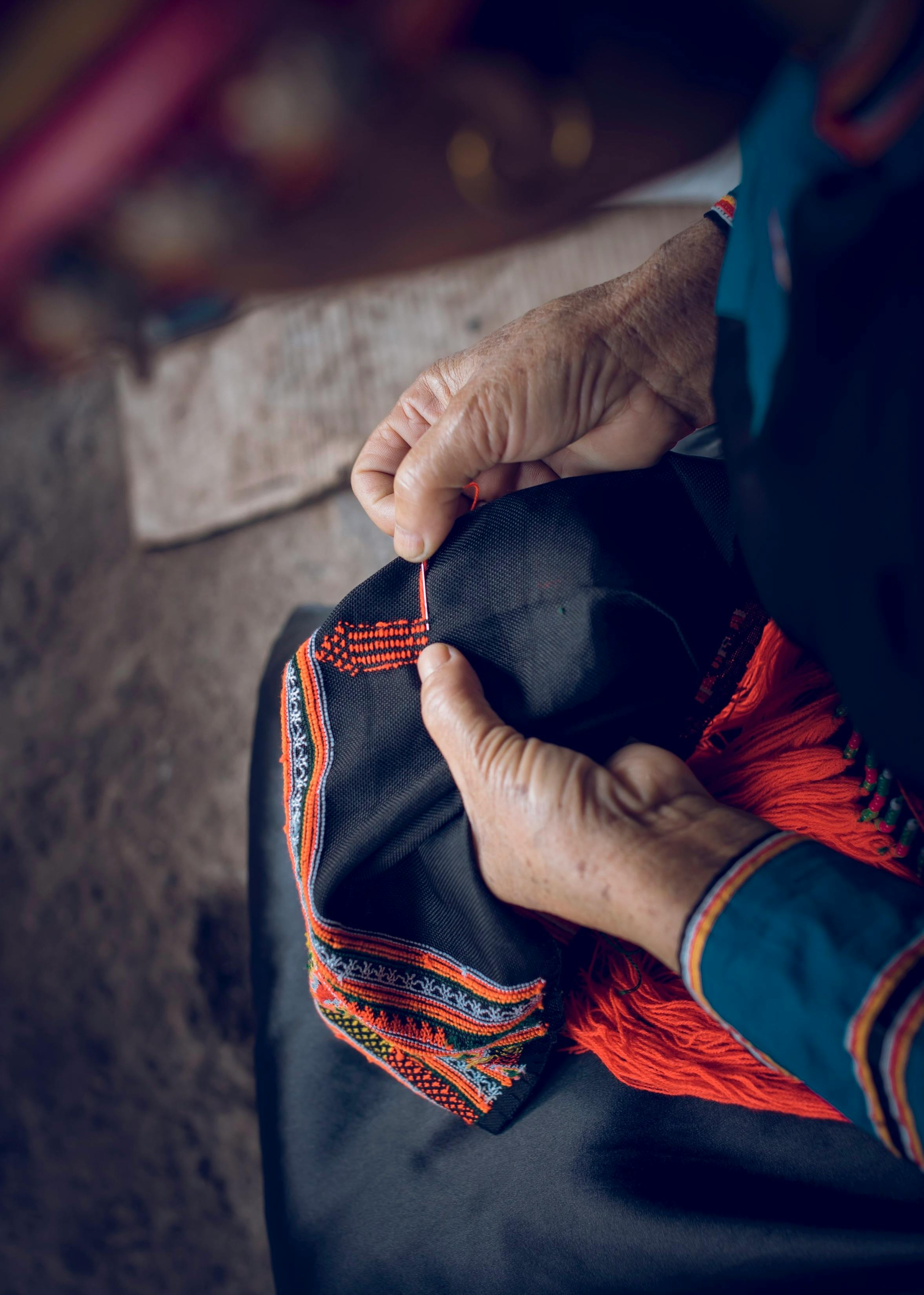 Elderly Person Embroidering Vibrant Fabric Close-Up · Free Stock Photo